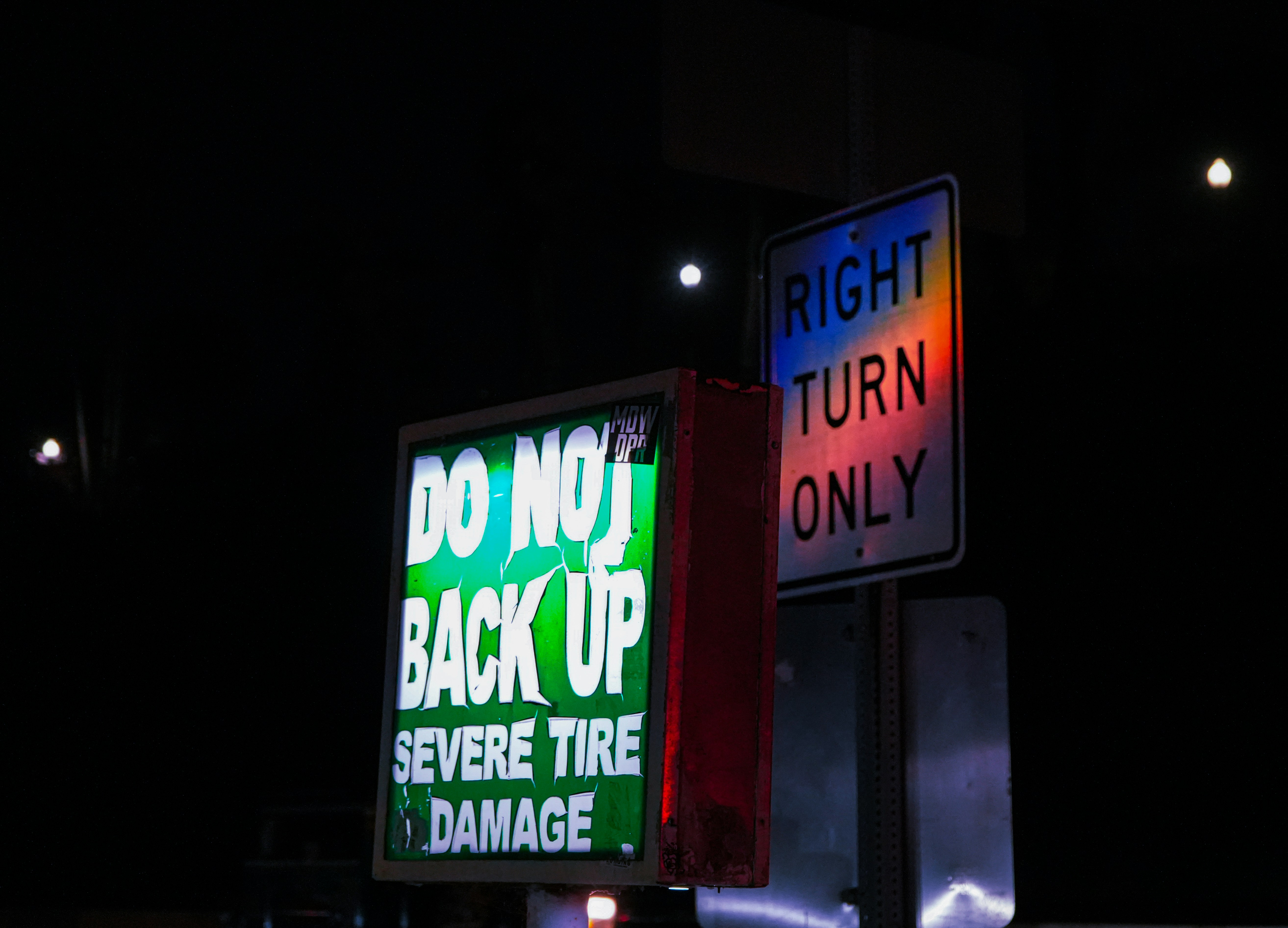 Neon Warning in the Night: Do-Not-Back-Up Sign Casts a Glow
