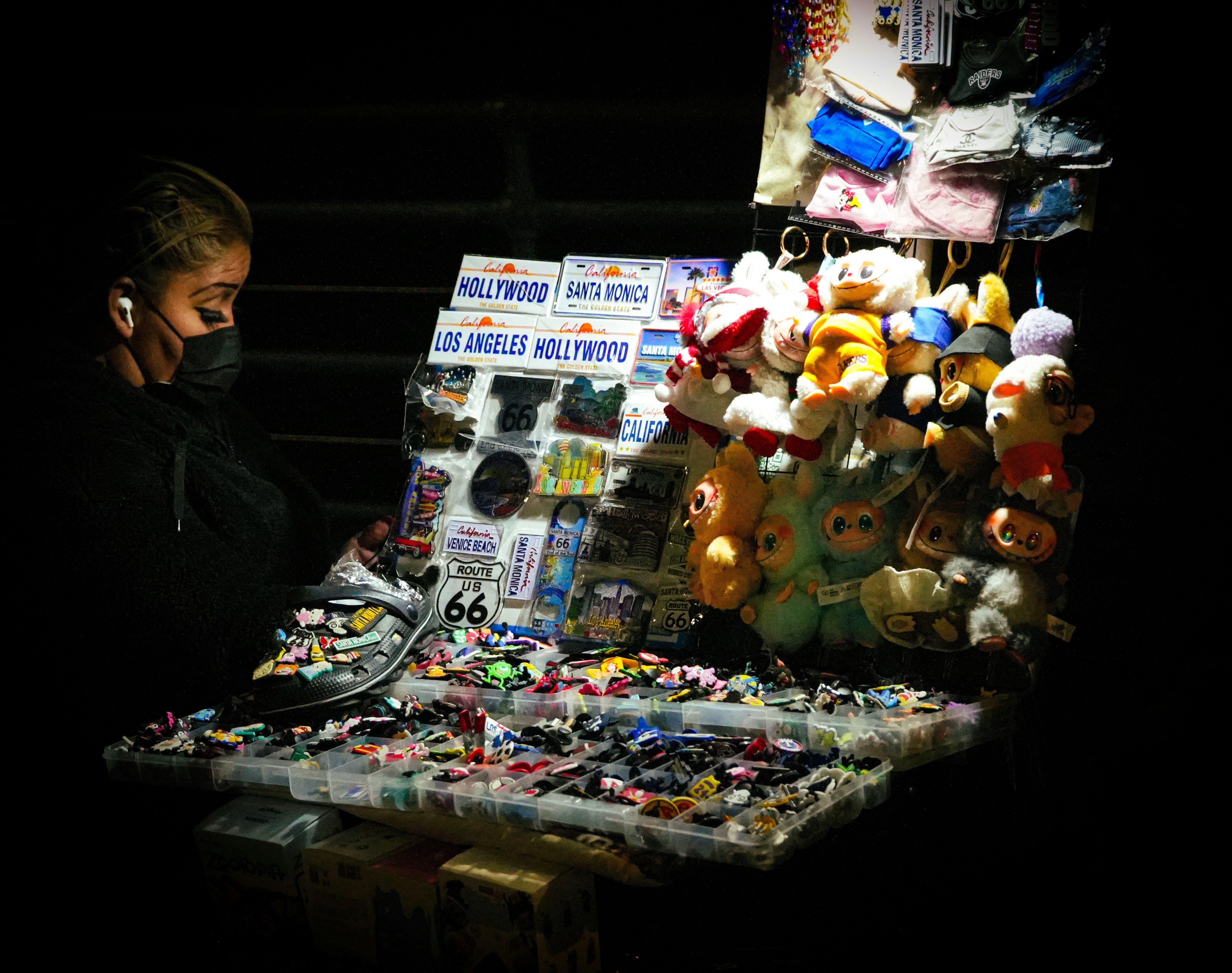 Night Market Spotlight: Masked Vendor Illuminates a Toy Stall