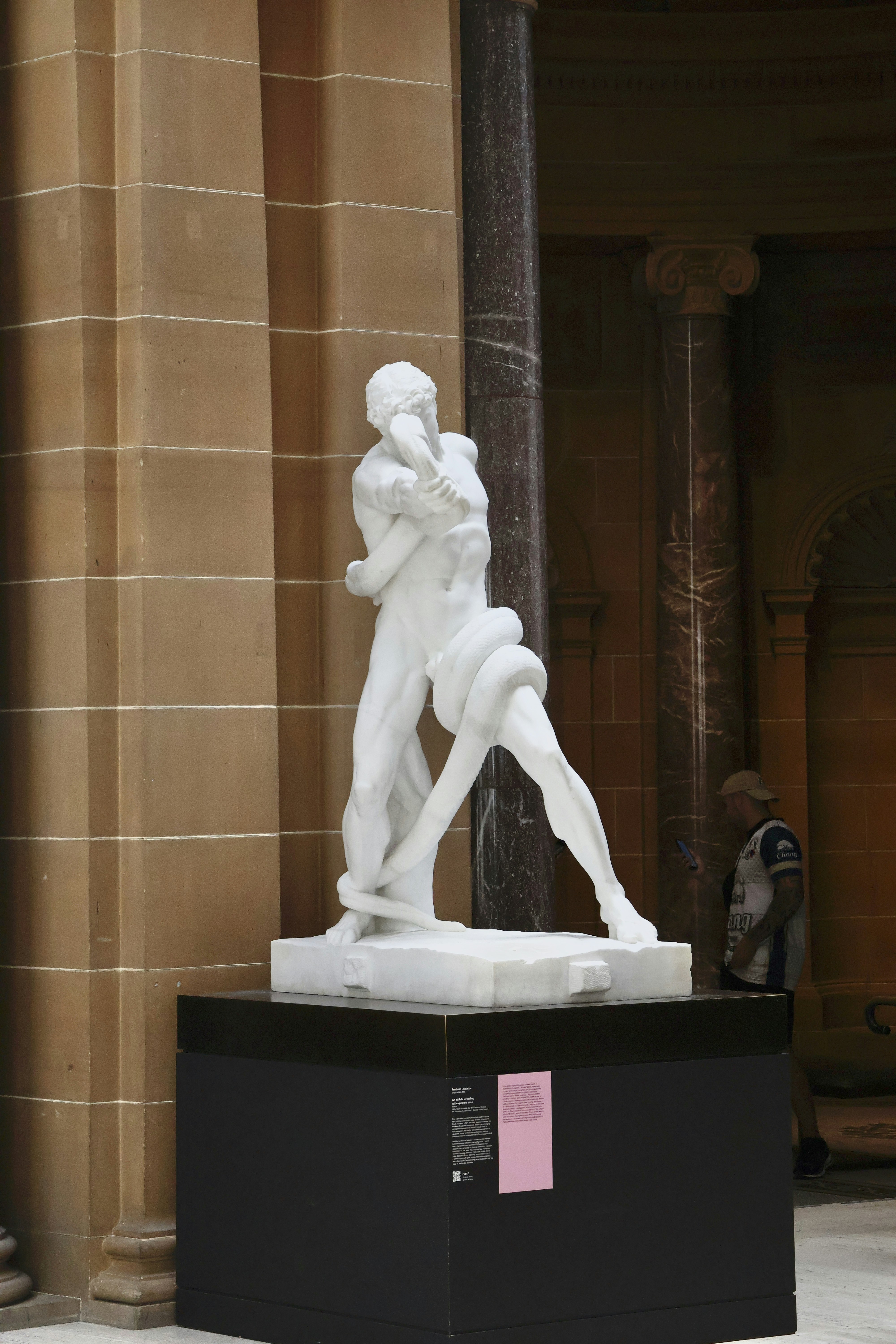 Strained Embrace: A Marble Couple in Shadowed Colonnade