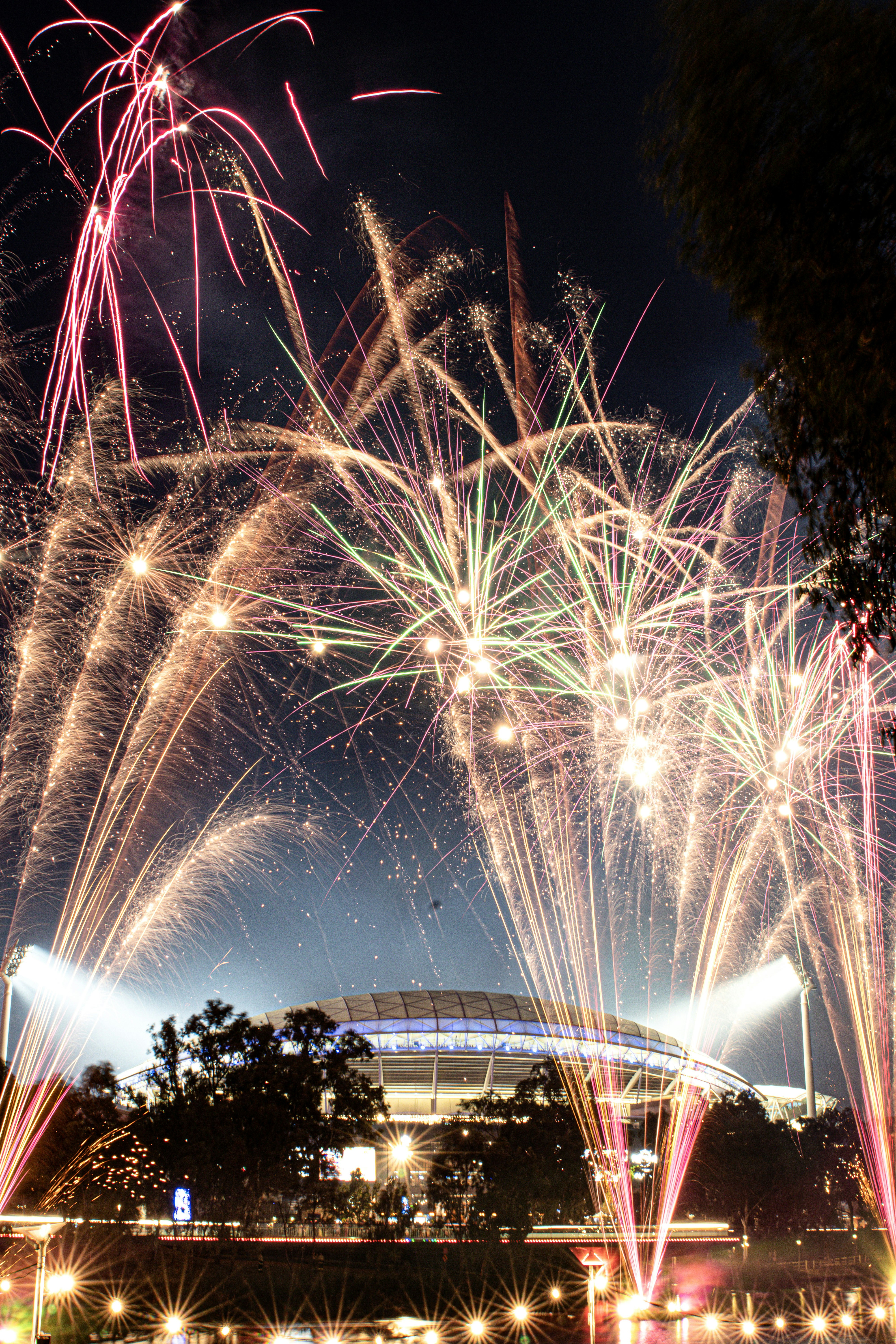 Night Sky Fireworks over a Stadium Panorama