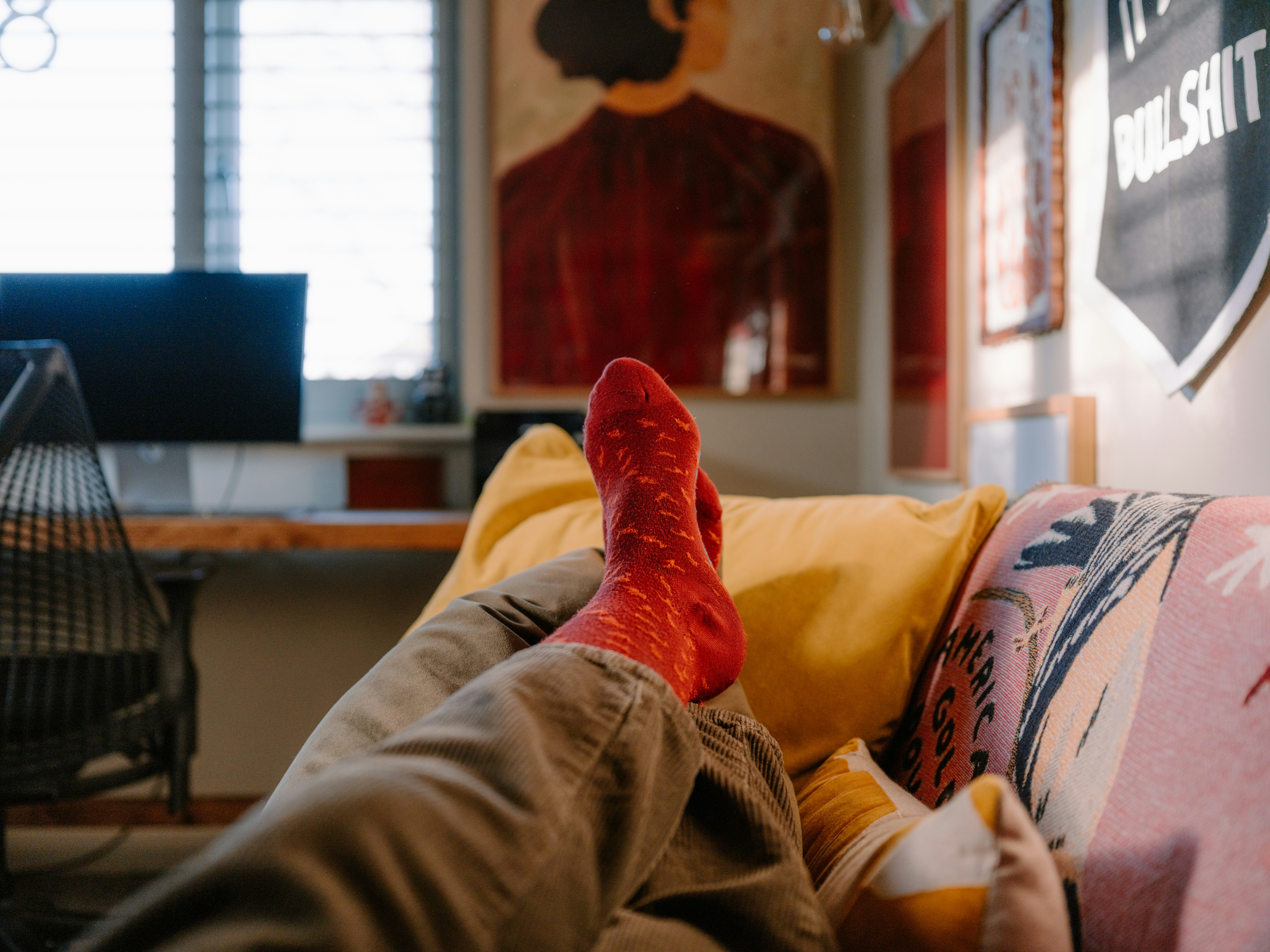 Person relaxing on couch with feet up