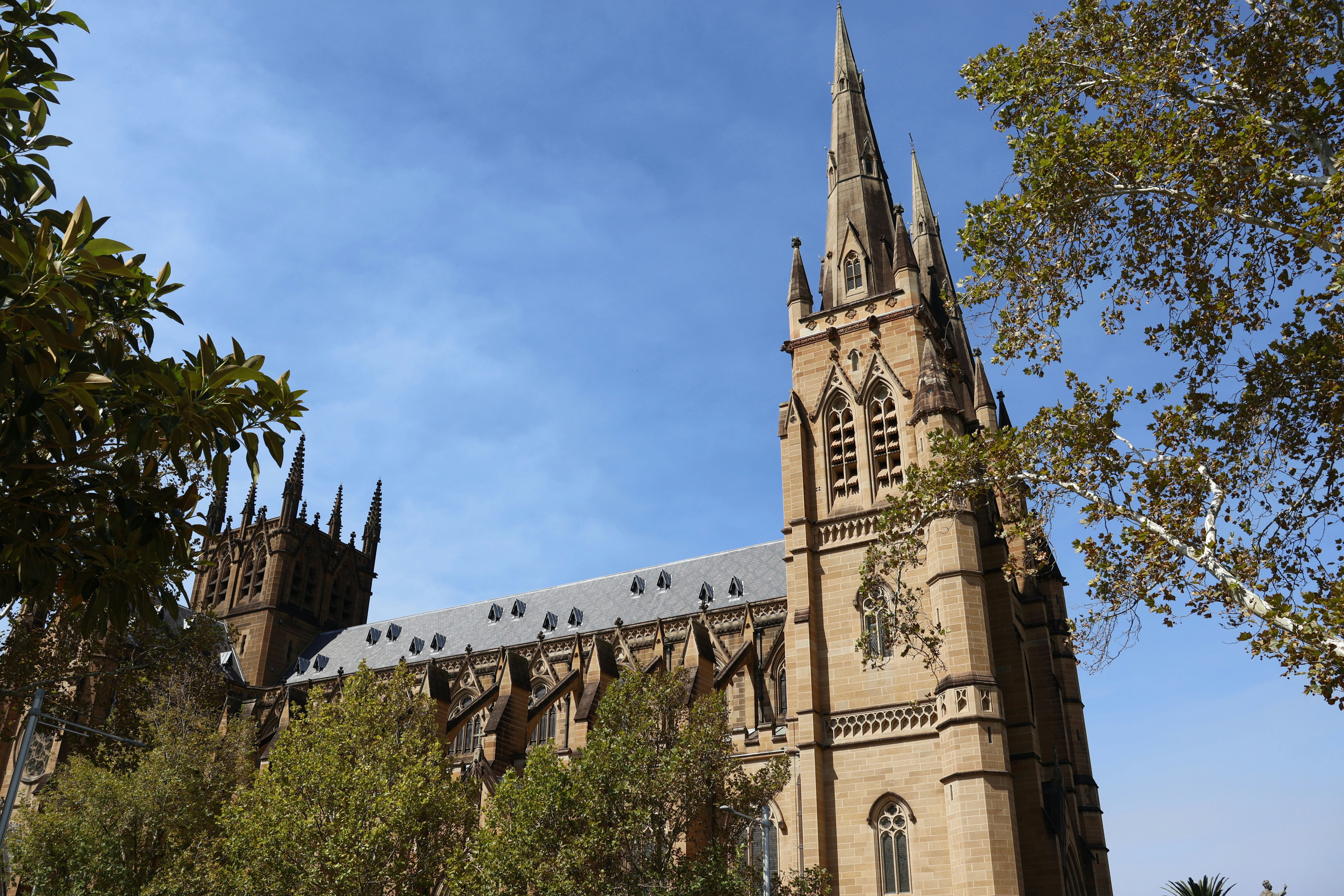 Gothic cathedral with tall spires against blue skyYou Le