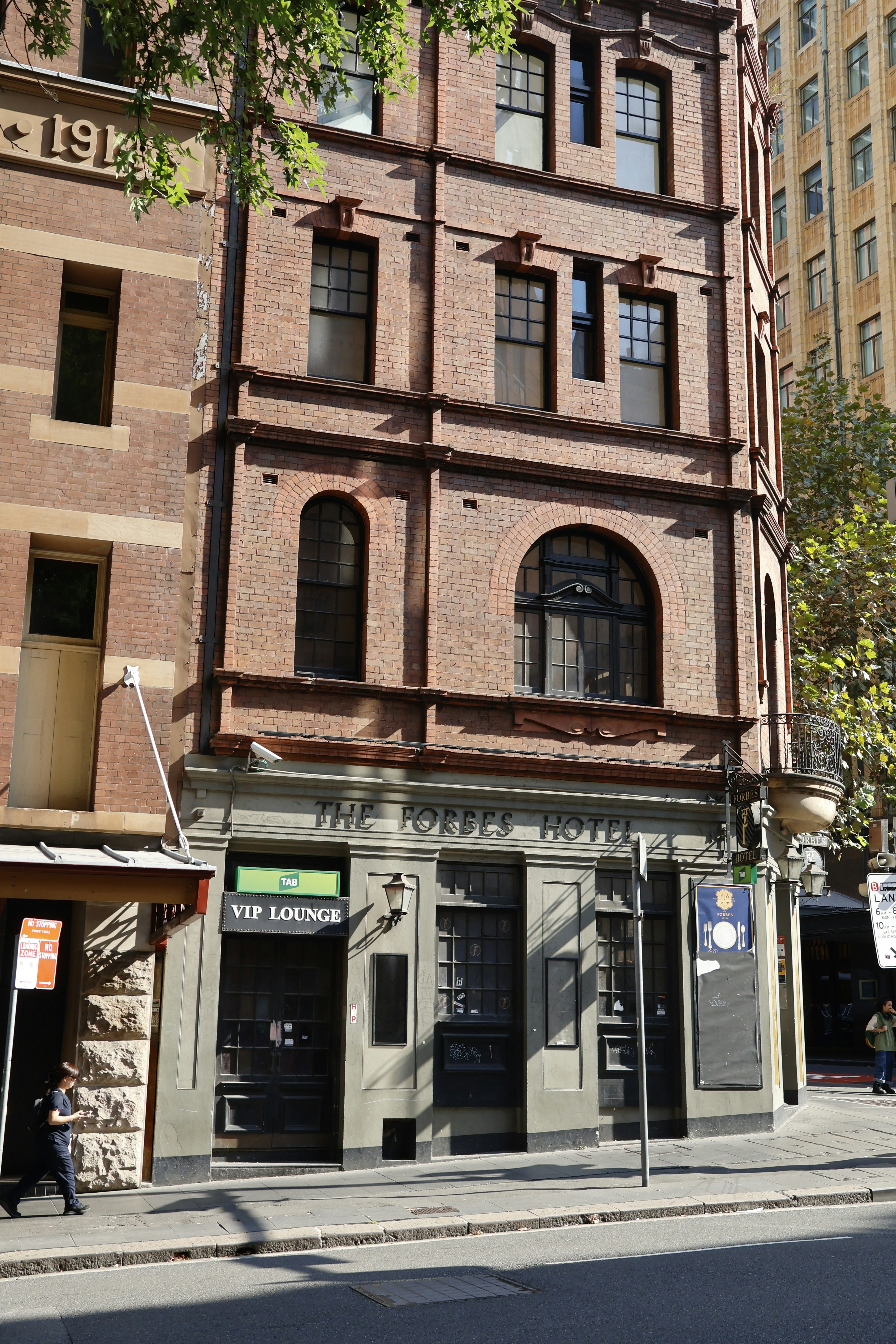 The Forbes Hotel Façade: Brick Detailing and Shadowed Entrance