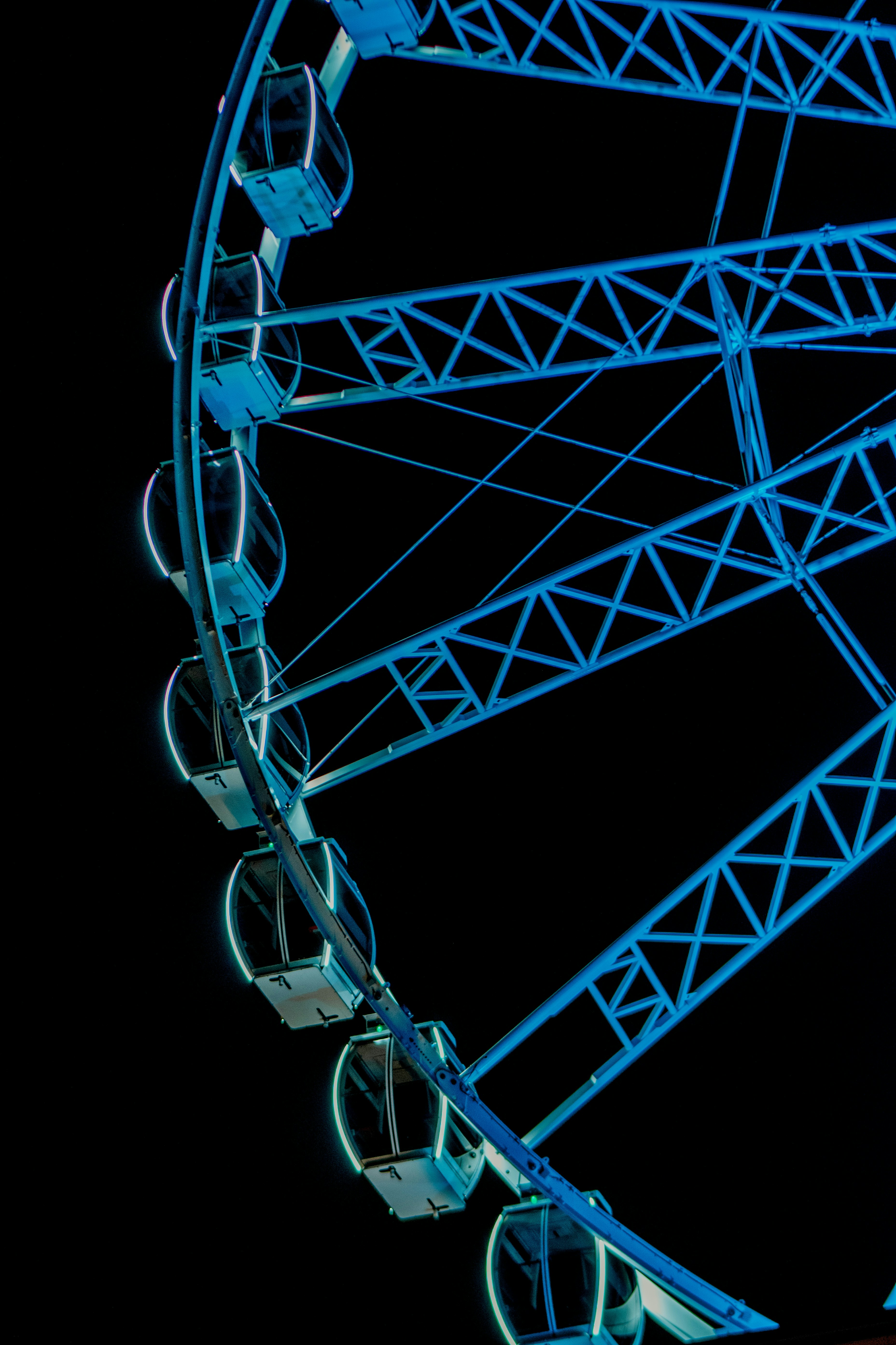Neon Blue Ferris Wheel Silhouette Under Night Sky