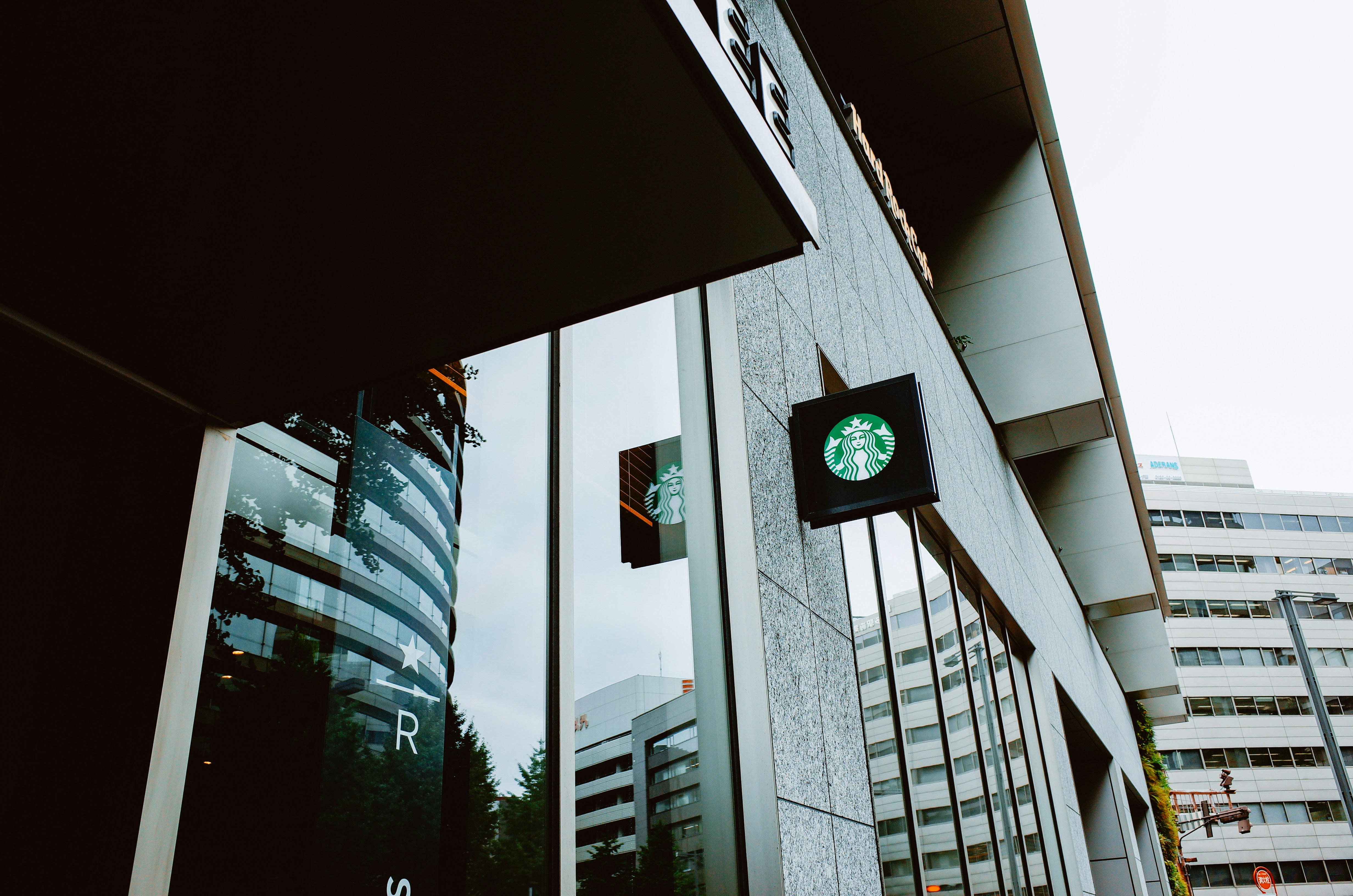 Starbucks Sign Framed by Modern Facades
