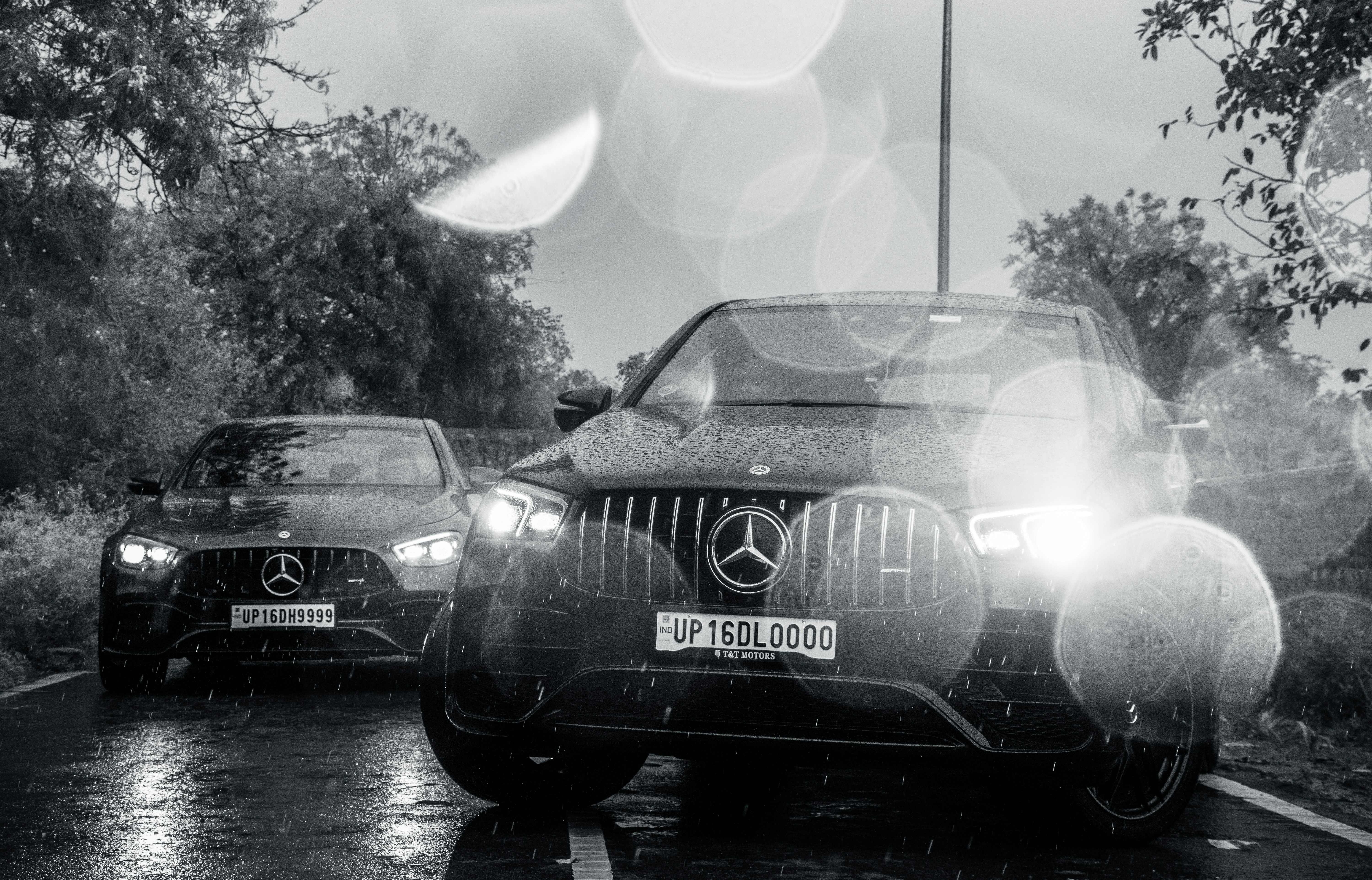 Two mercedes-benz cars driving on a wet road. photo – Free Car Image on ...