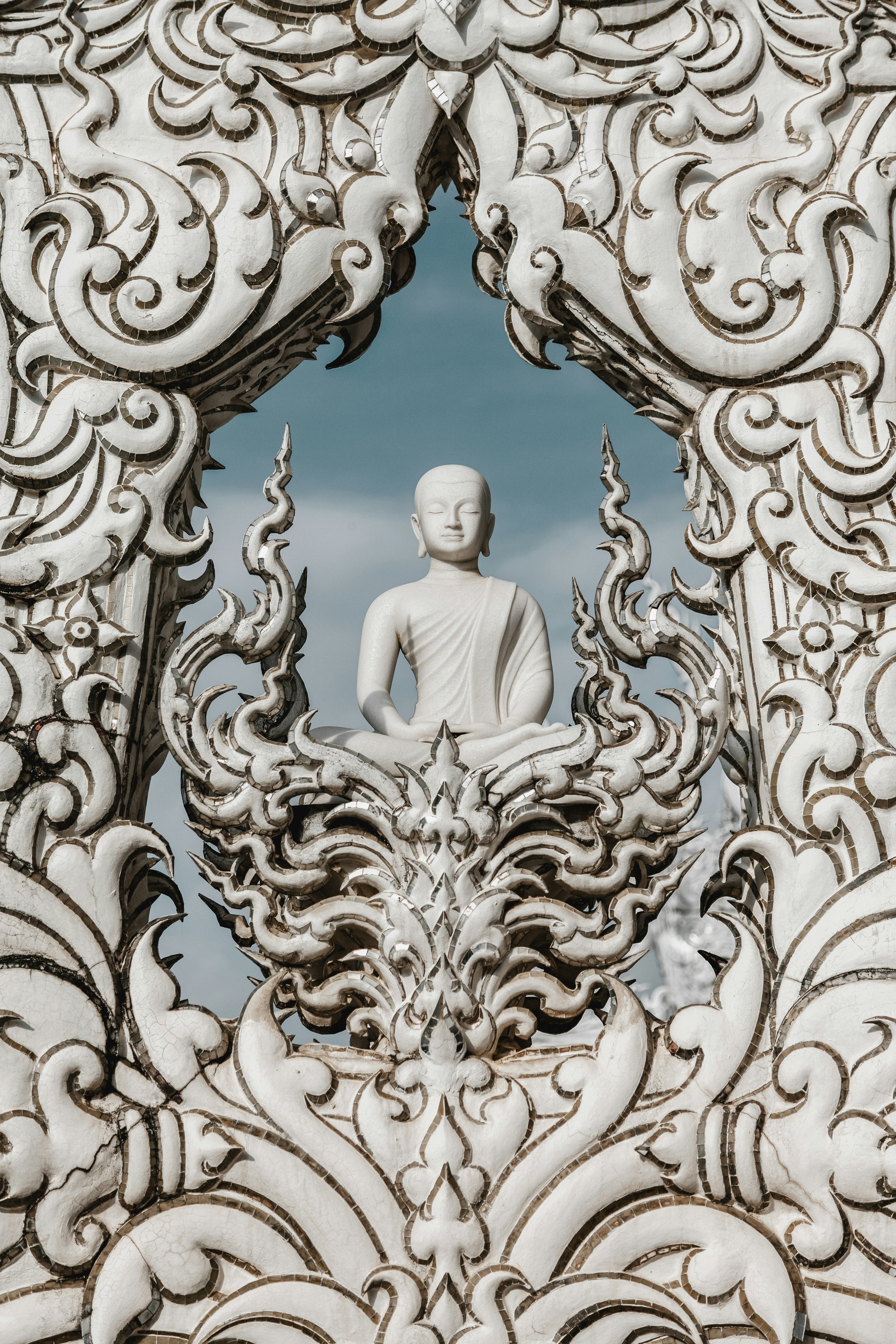 Mid-Garden Gate: Silent Buddha Framed by Ornate Carvings