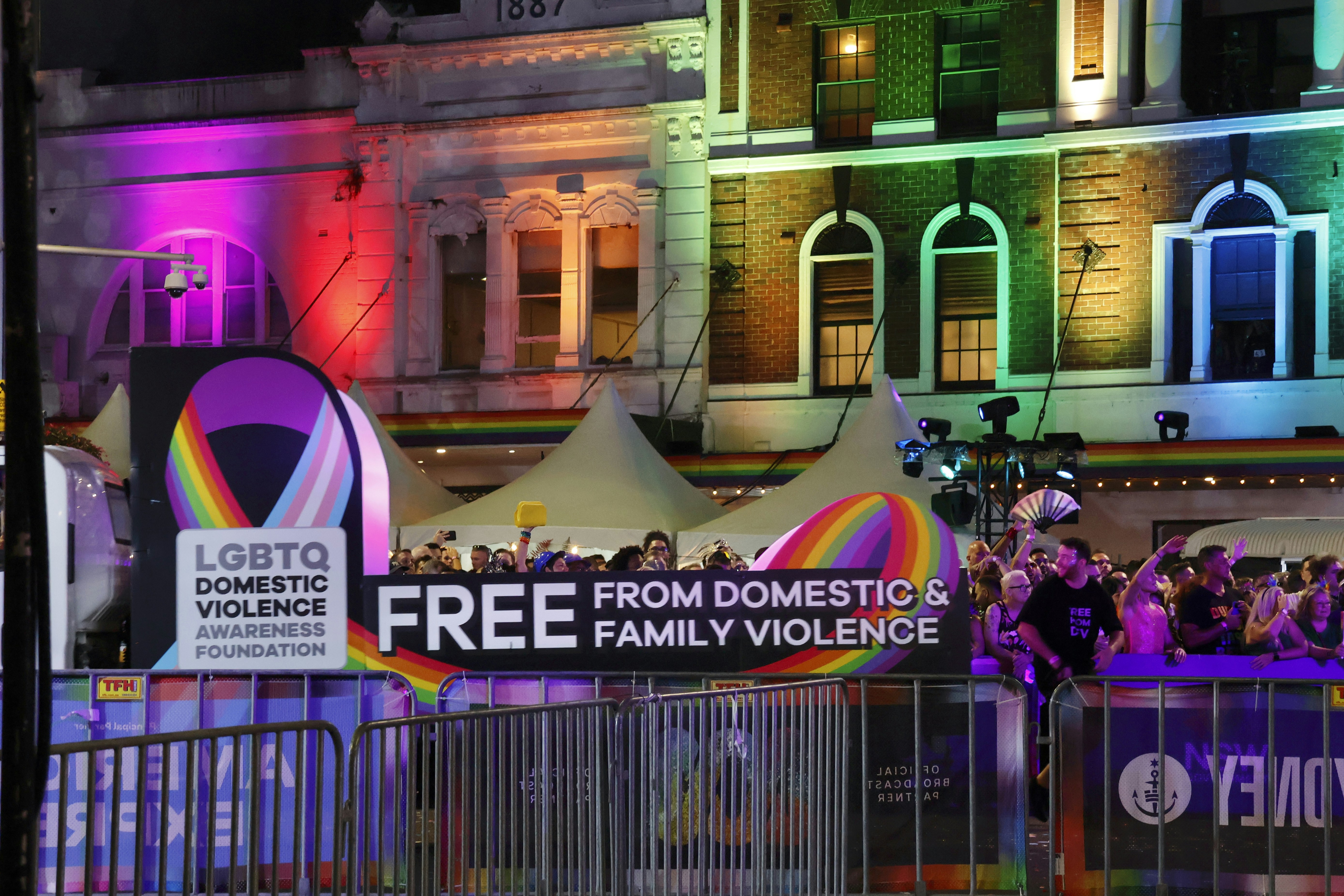 Rainbow Night: Pride Parade Banner Amid Historic Facade