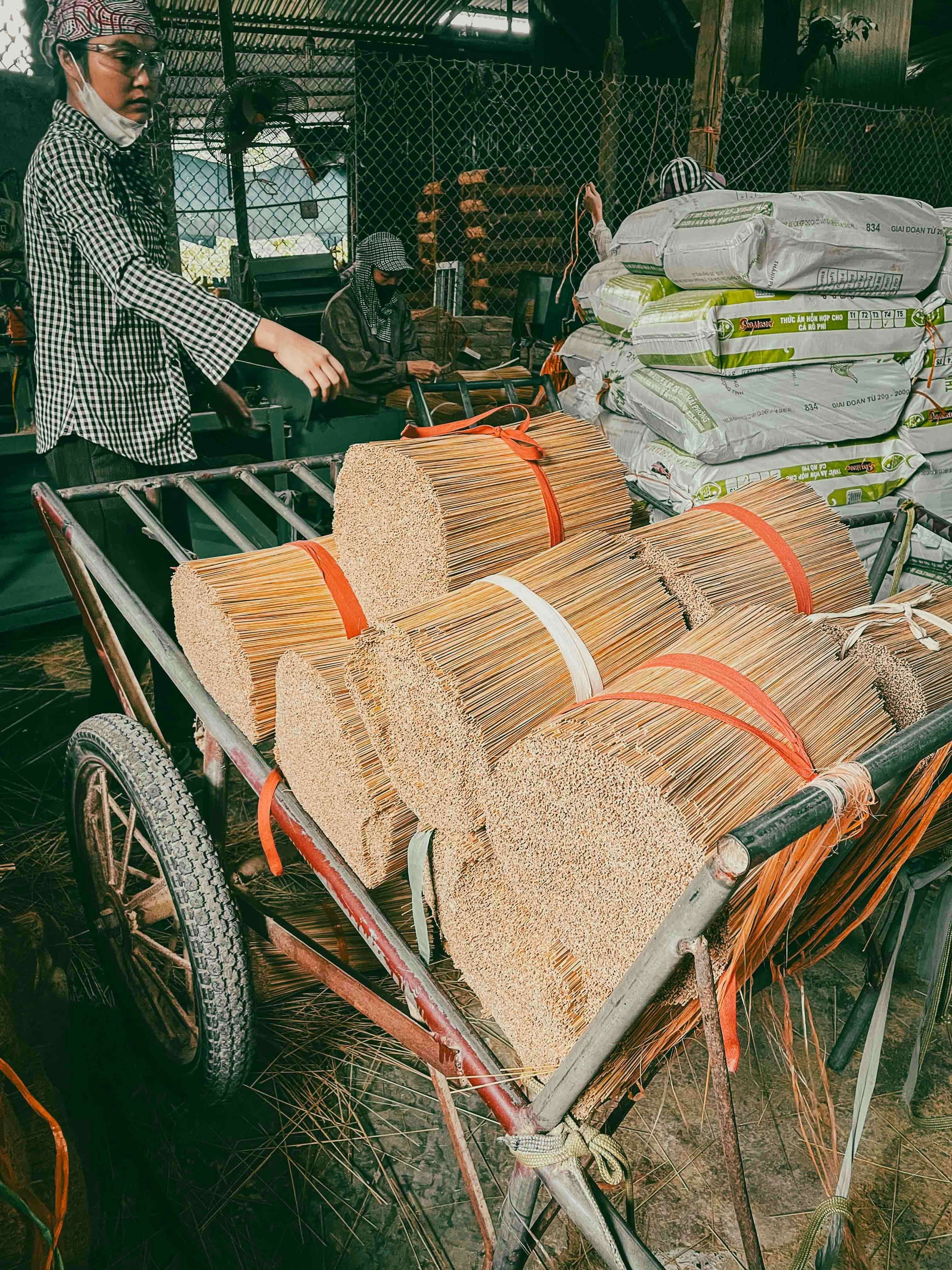 Cart of Ceramic-White Brimmed Strips: A Worker’s Moment in a Bamboo-Trim Workshop