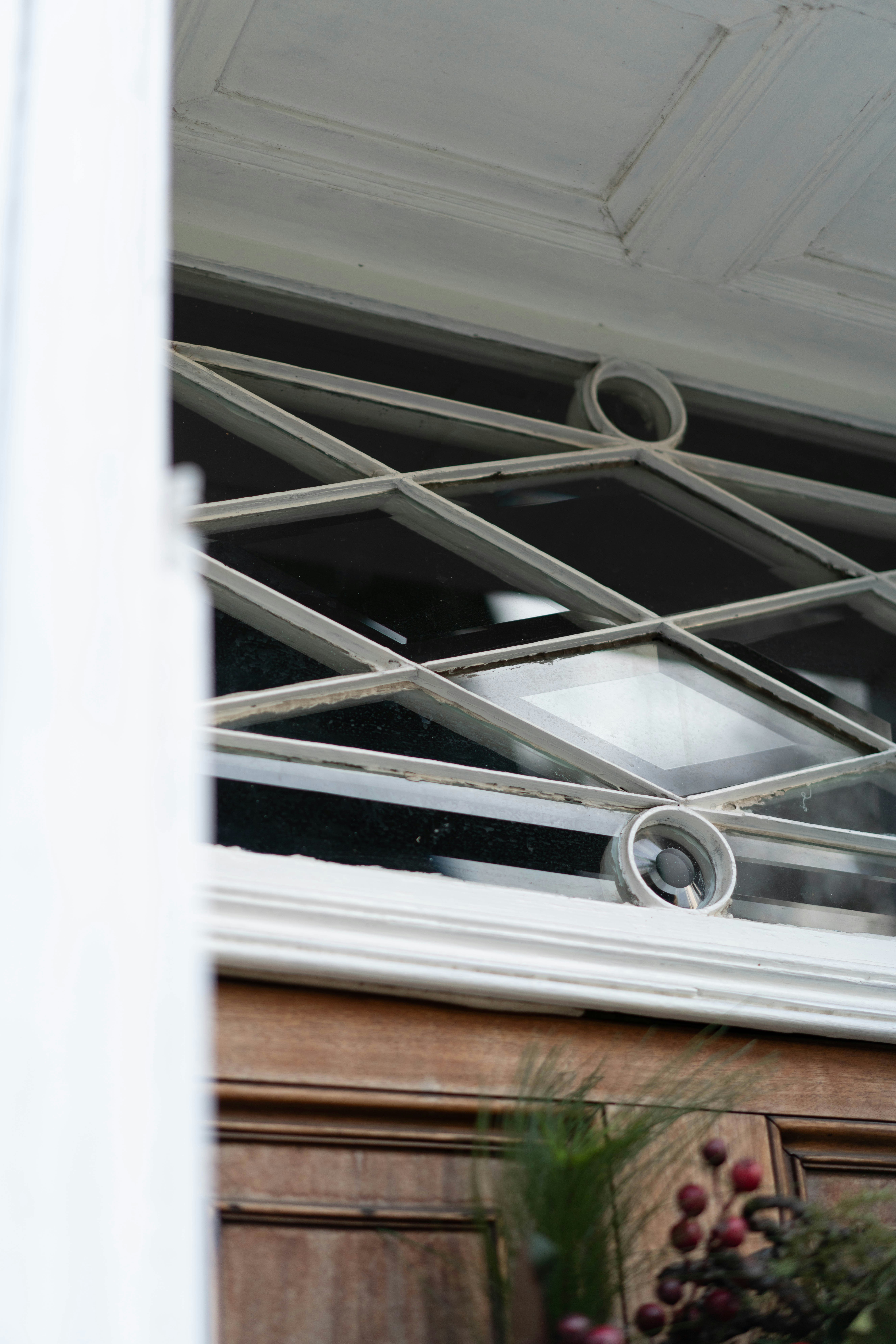 Architectural Window Lattice Framing a Closed Door