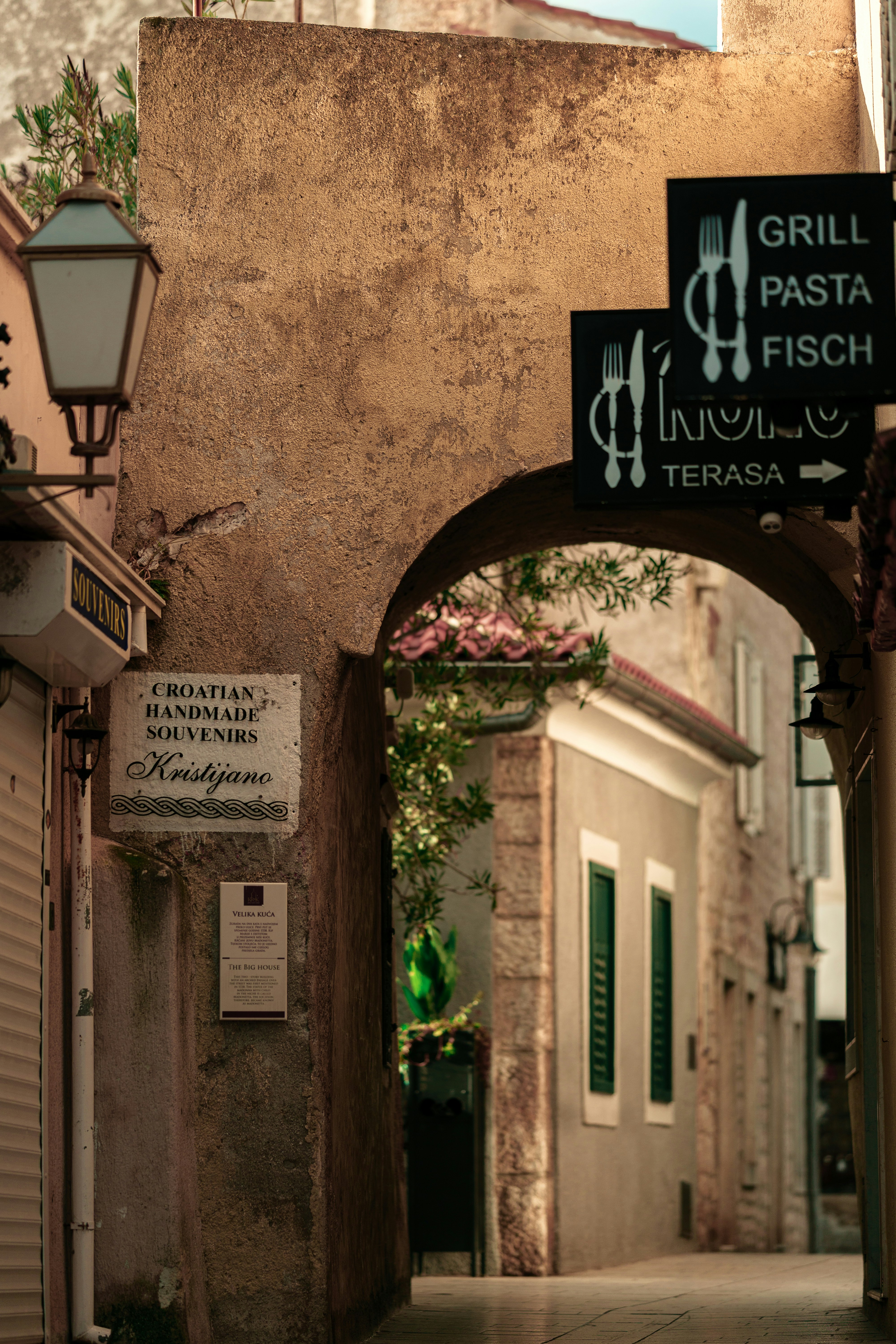Archway into a sunlit Mediterranean Alleyway