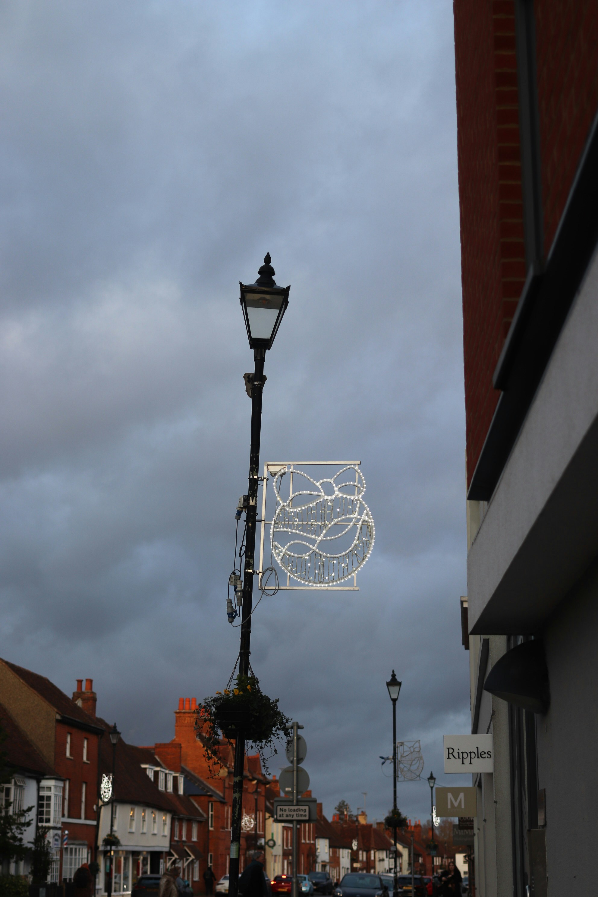 Street Lantern and Illuminated Ornament in a Shaded Town Corridor