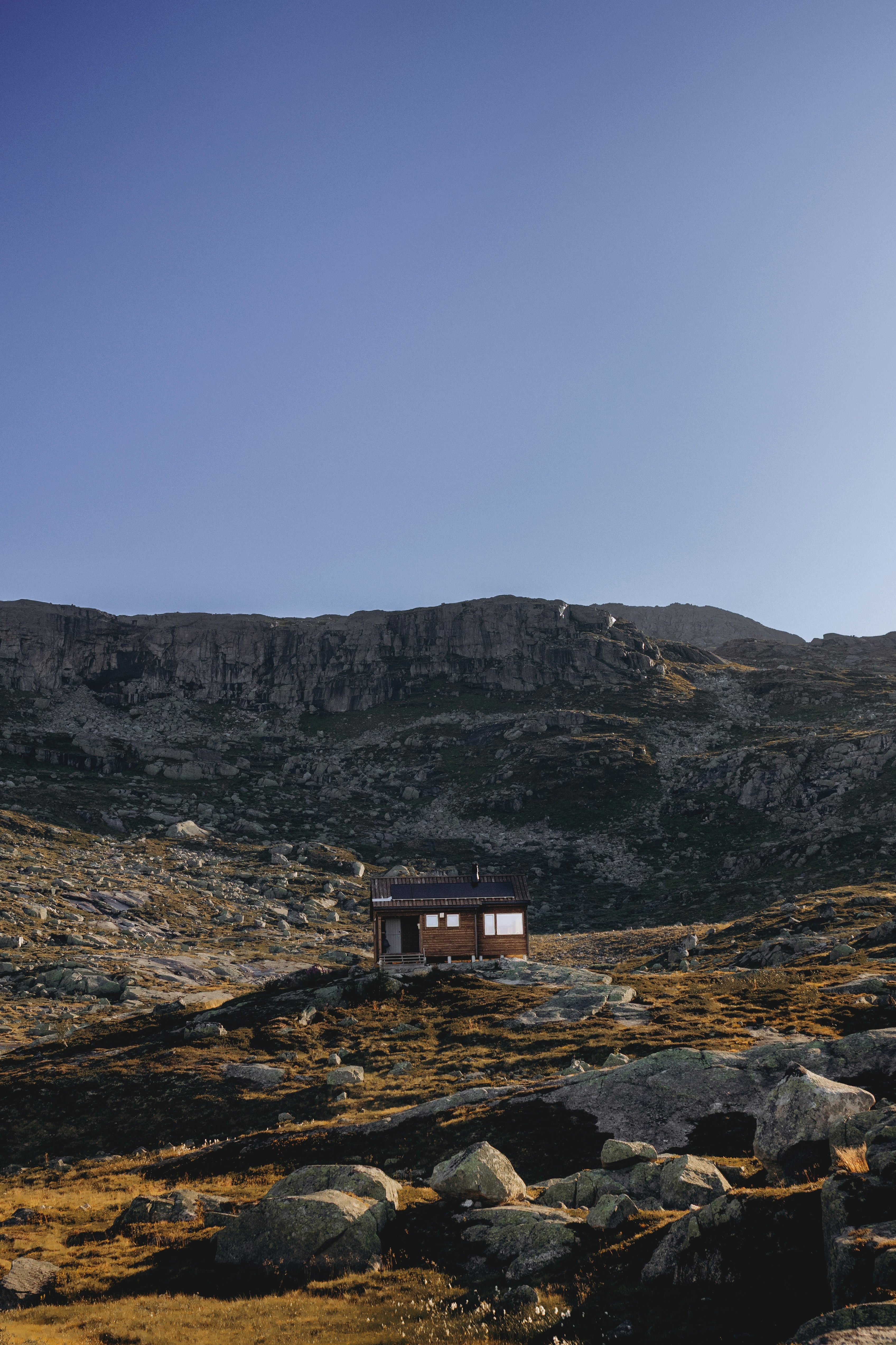 A Mountain Hut Beneath an Expansive Blue Sky