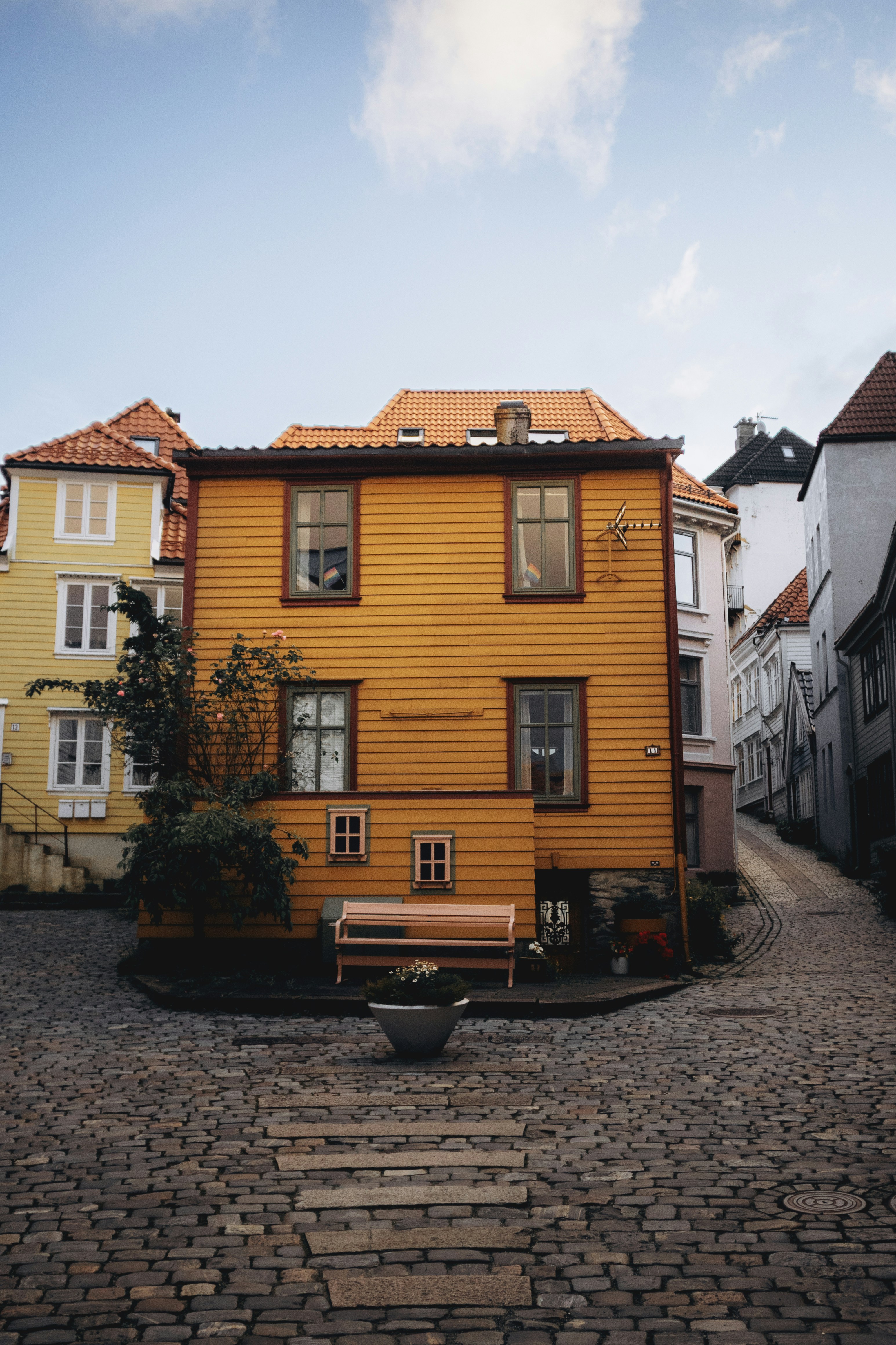 Sunlit Orange House on a Cobblestone Street