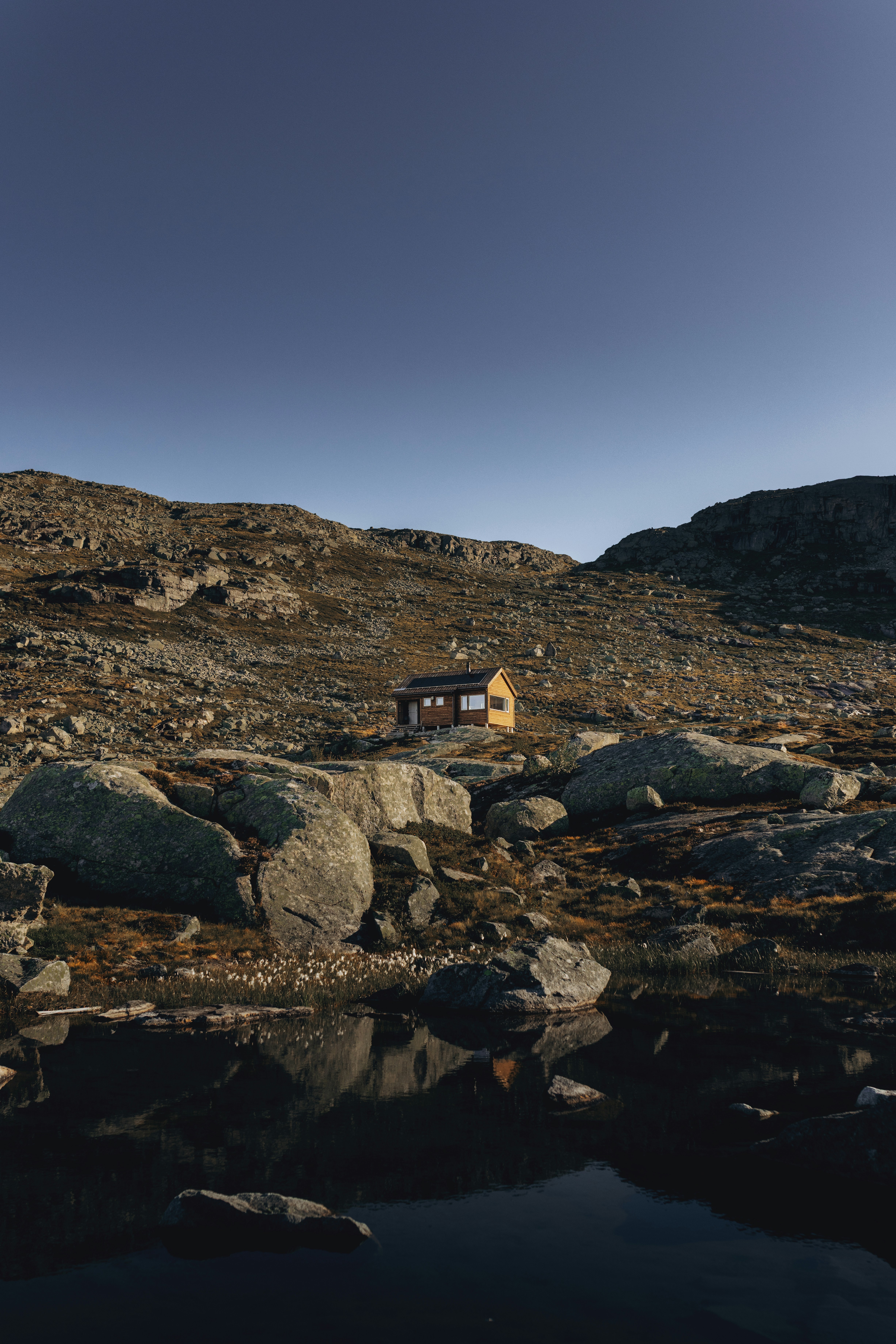 Harbor of Stone and Sky: A Lone Cabin Amid Alpine Barrenness