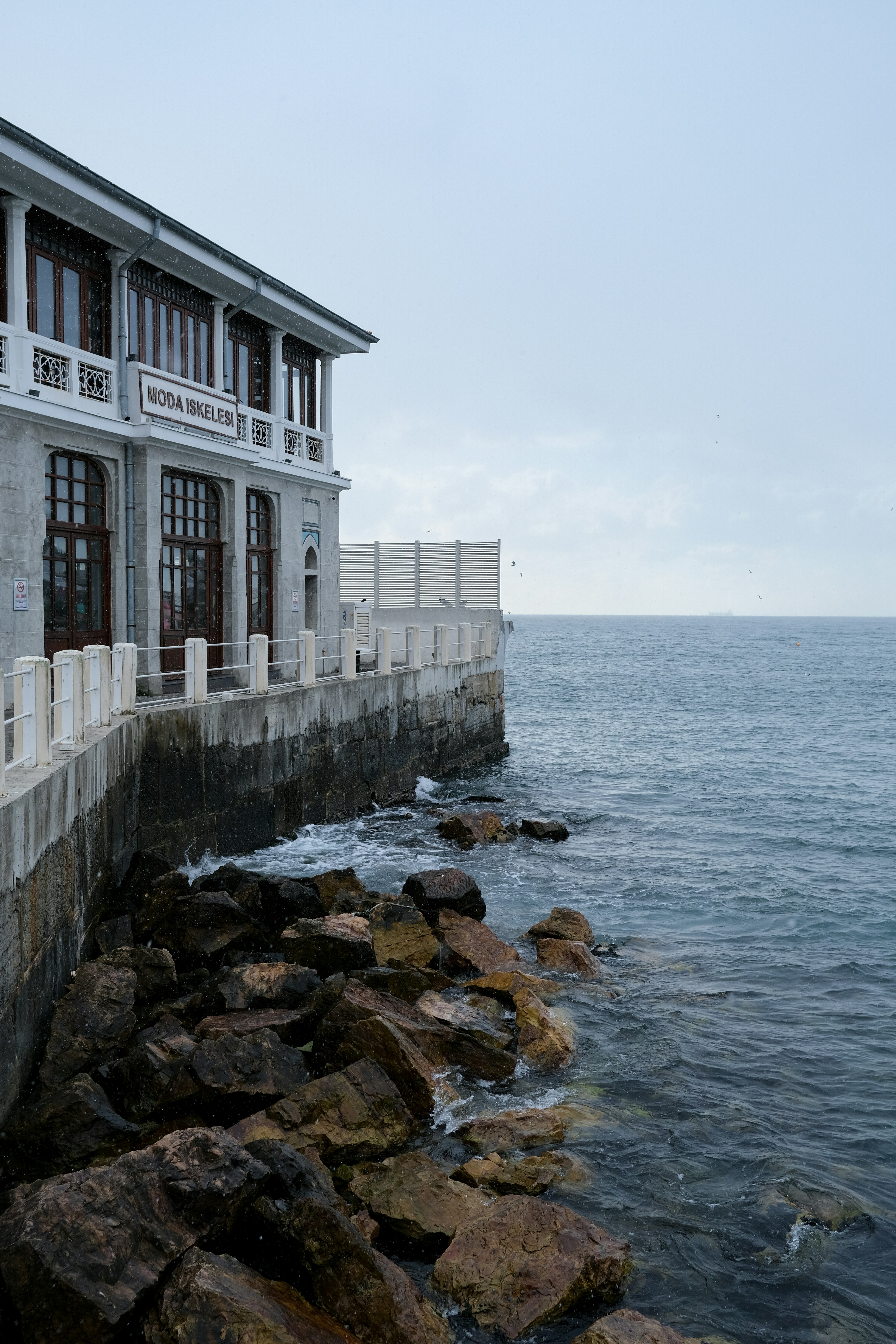 Building by the sea with rocky shore and wavy shore photo – Free ...