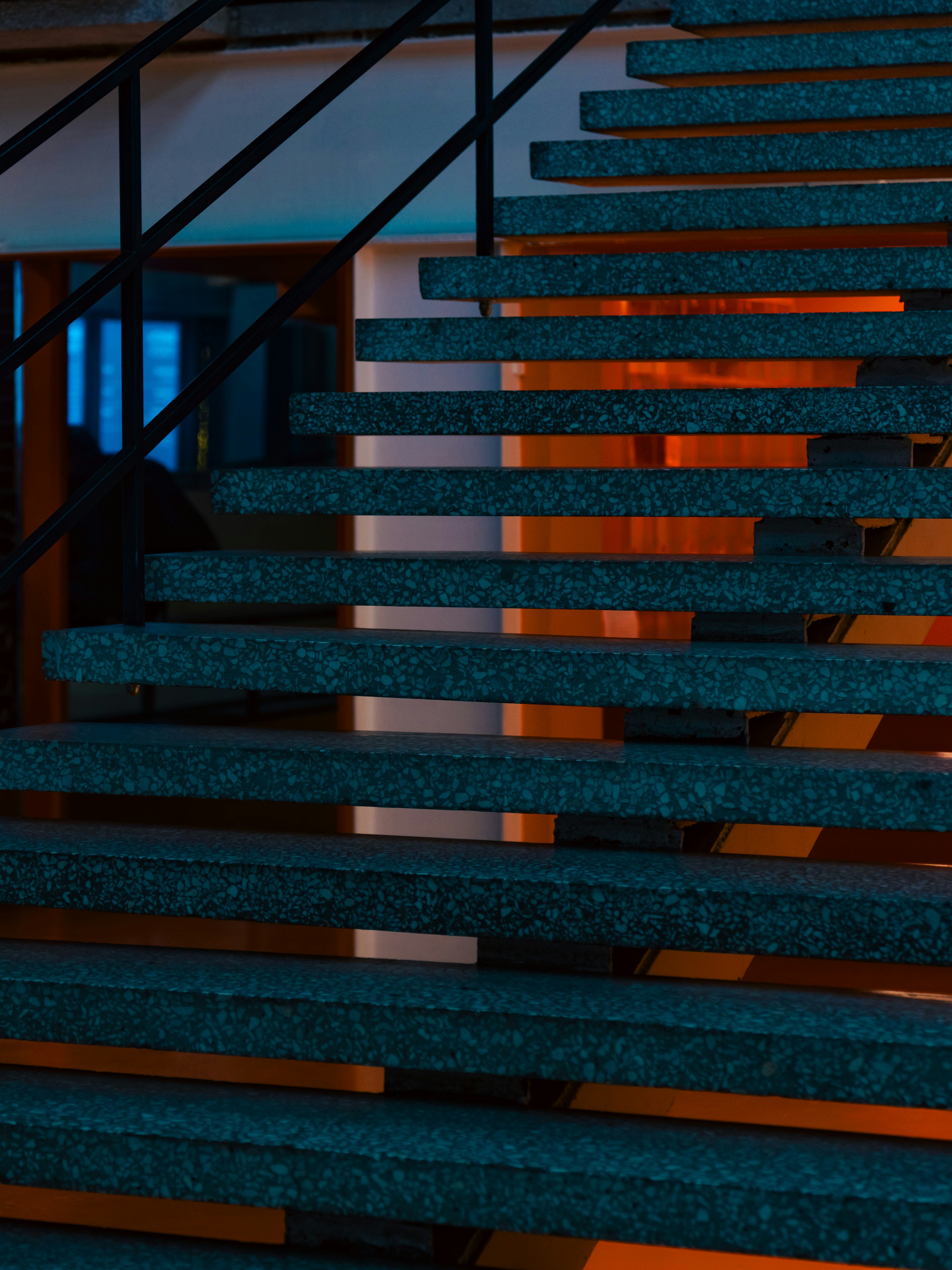 Industrial blue stairs fade into orange glow