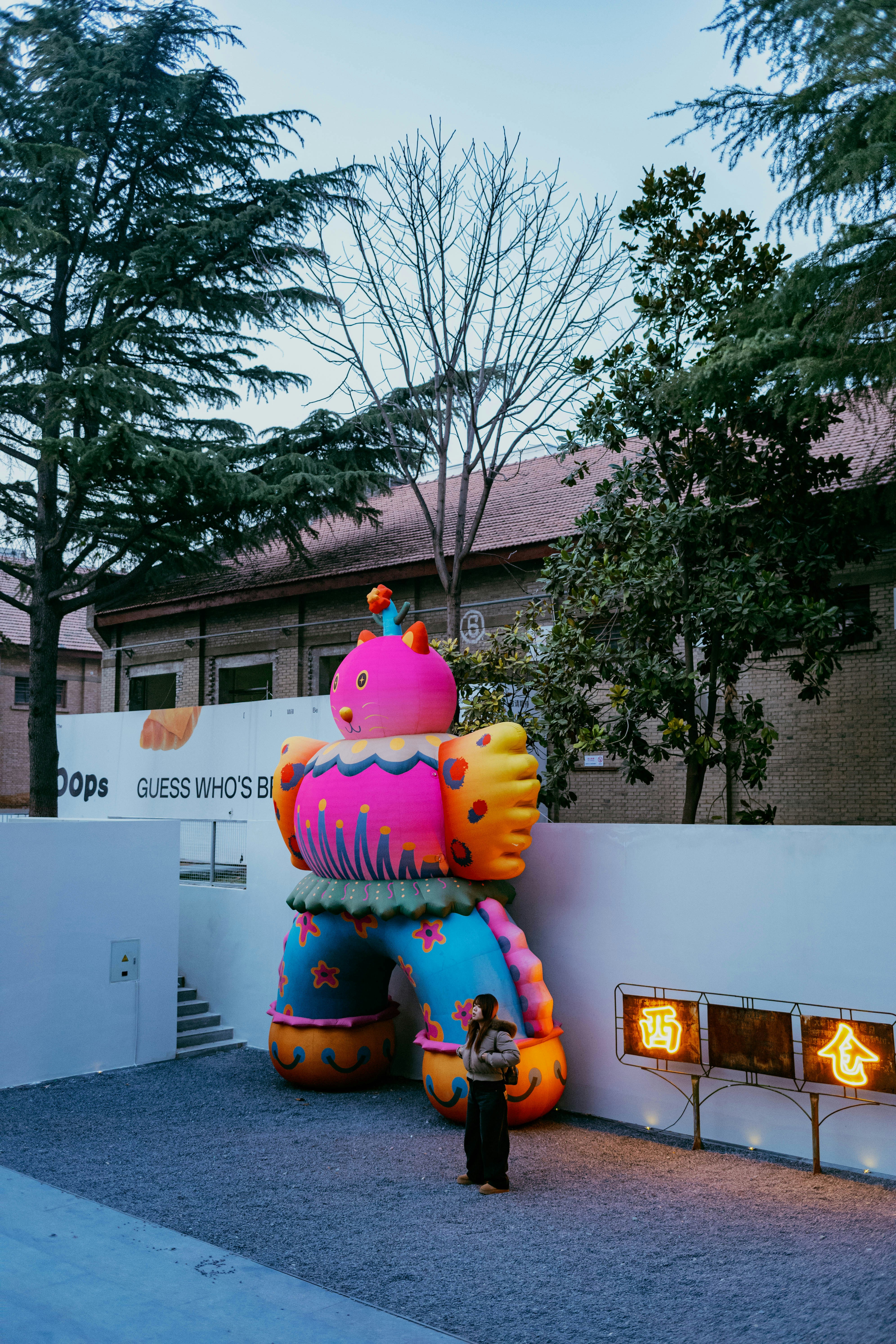 Inflatable Giant Cupid: A Quiet Moment by the Neon Gate