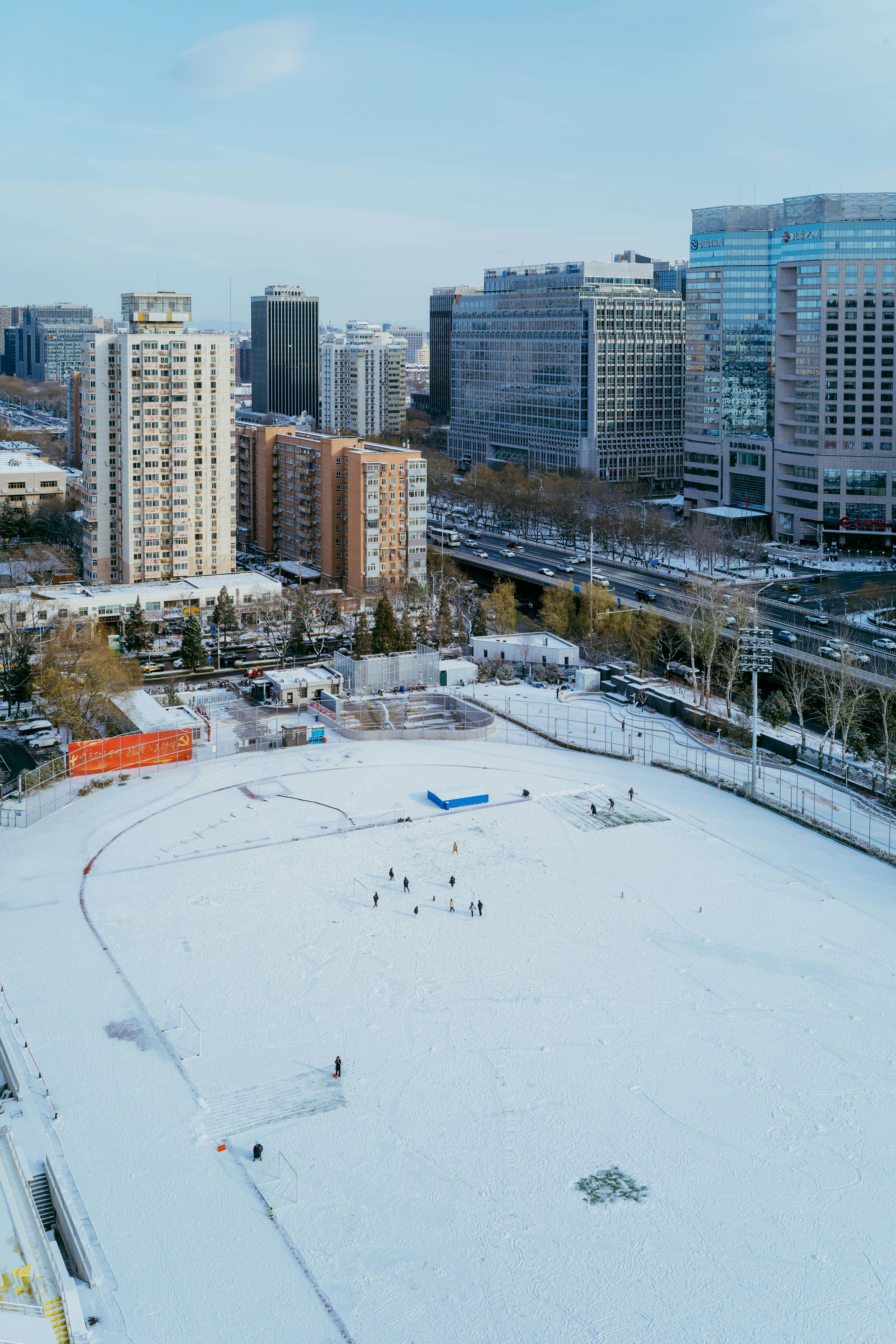 Winter Ice Rink Beneath a Modern City Skyline