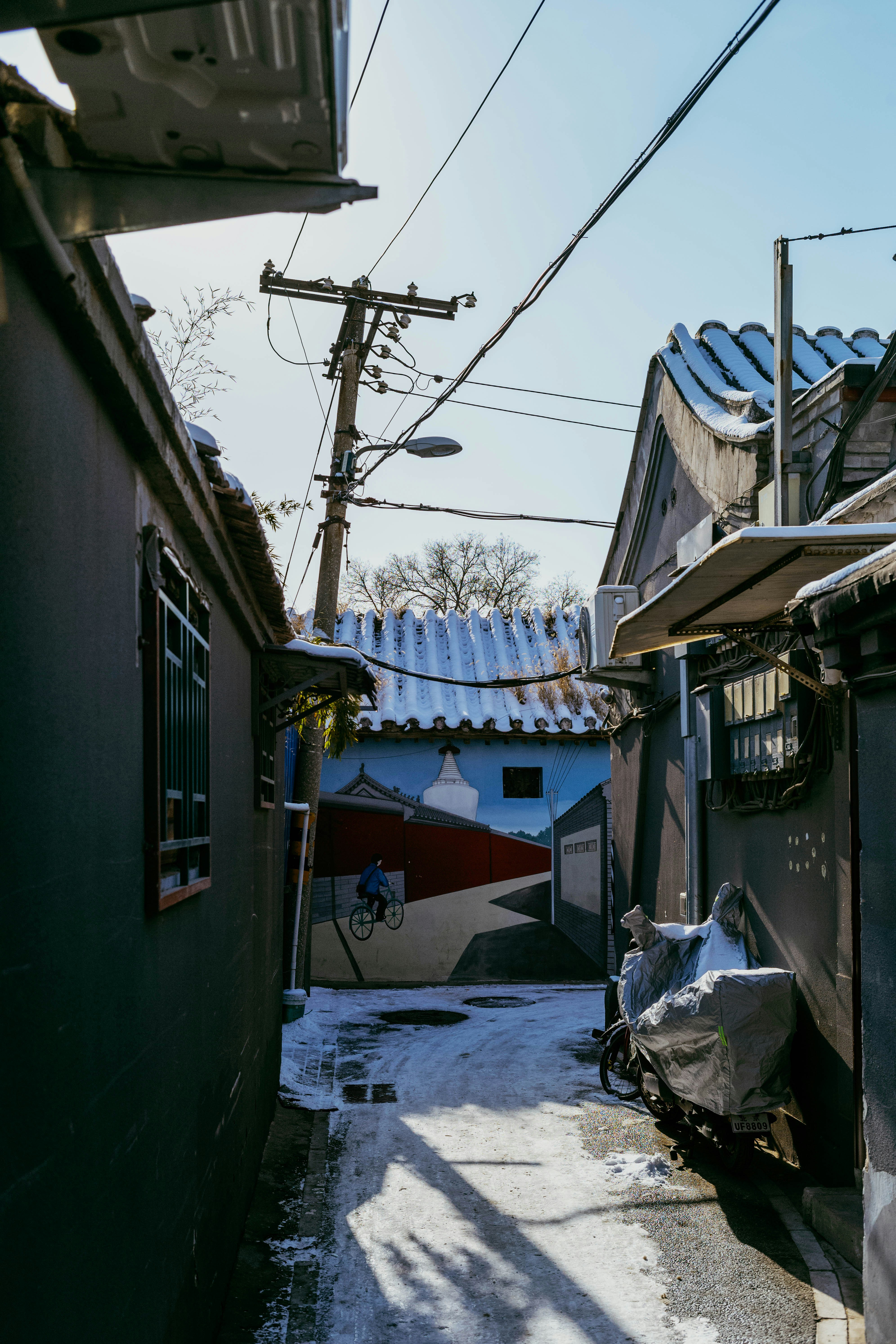 Snowlit Alleyway Between Quiet Rooftops