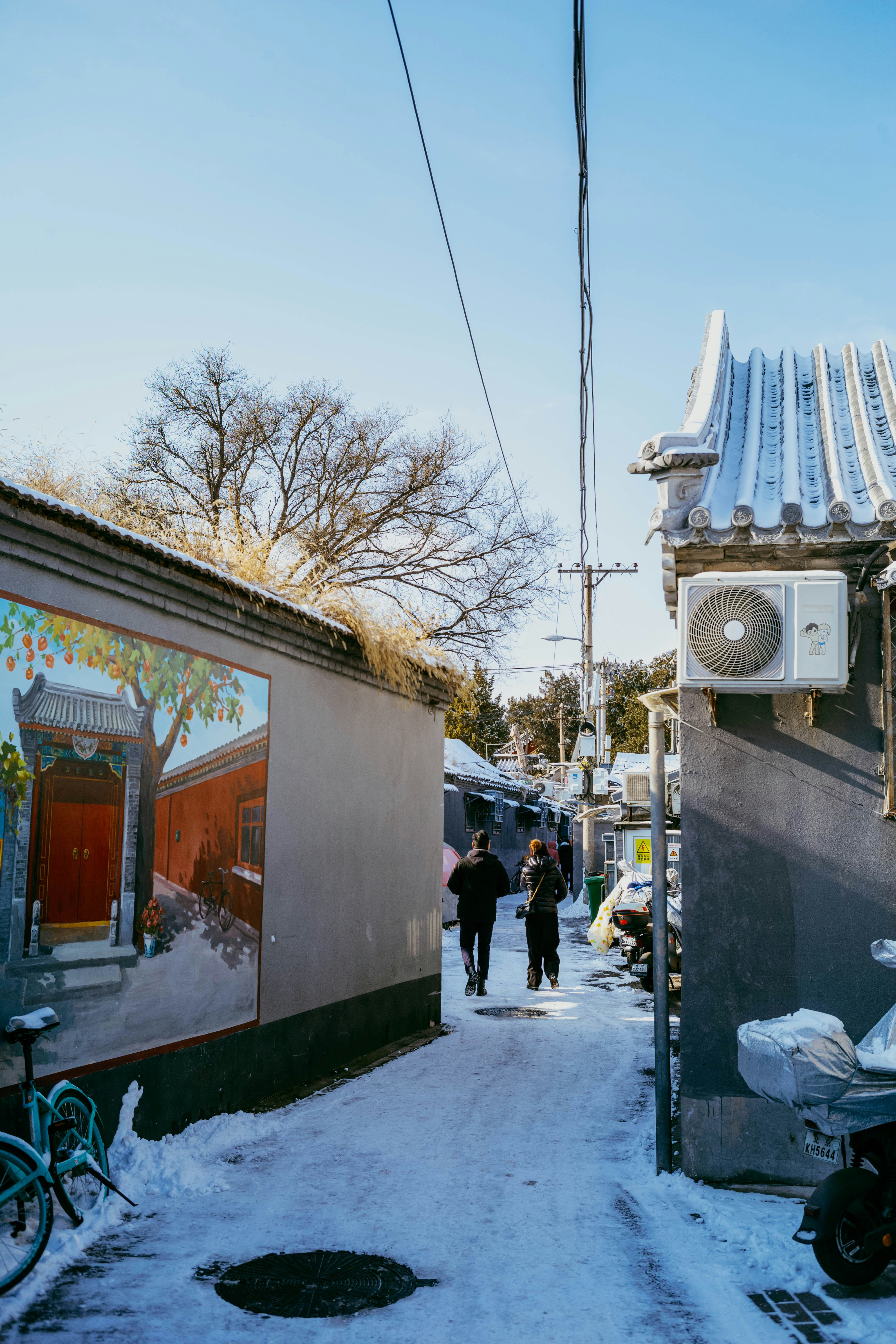 Snow-Cleared Alleyway Between Traditional Walls