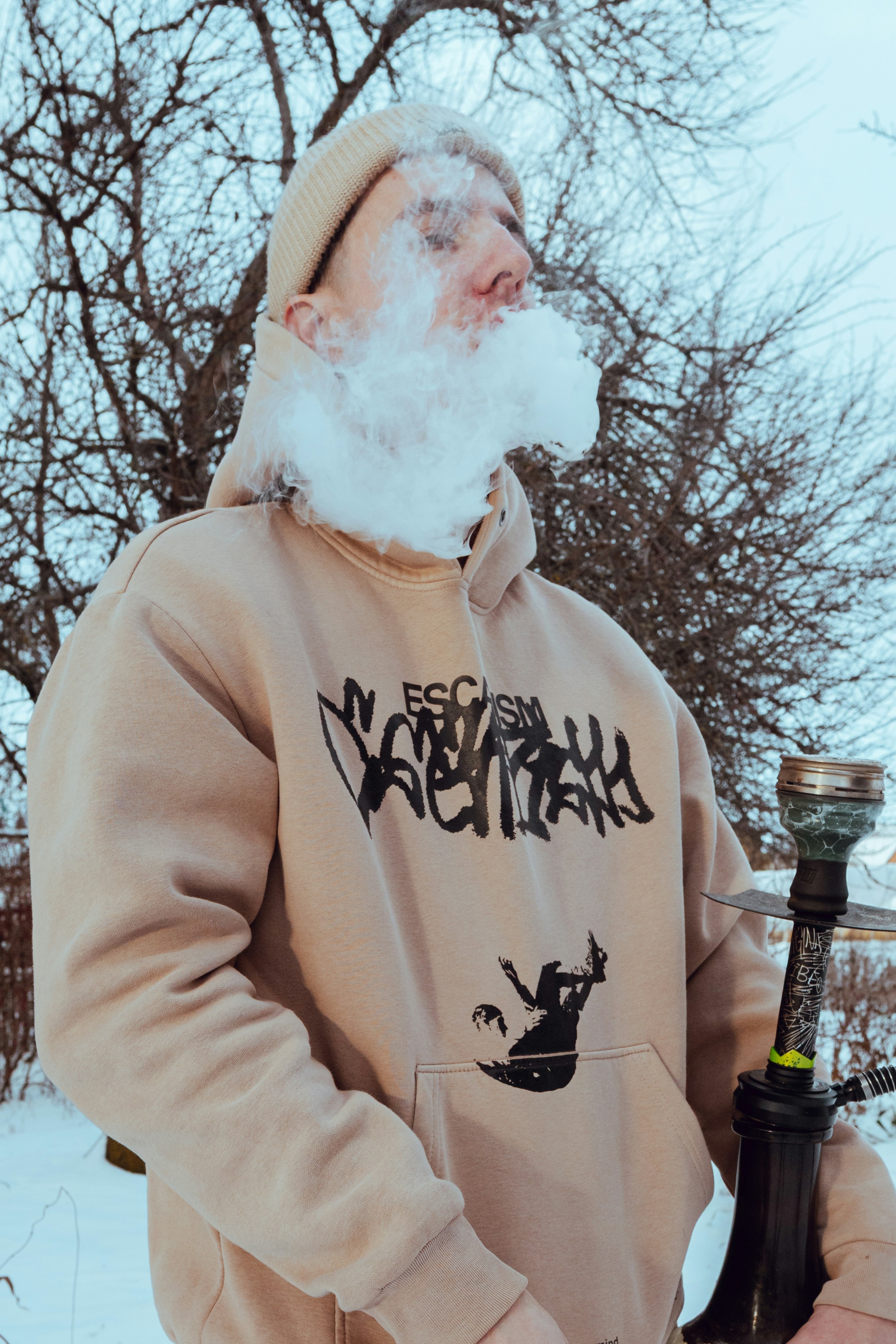 Man exhaling smoke from a hookah in the snow. photo – Free Winter Image ...