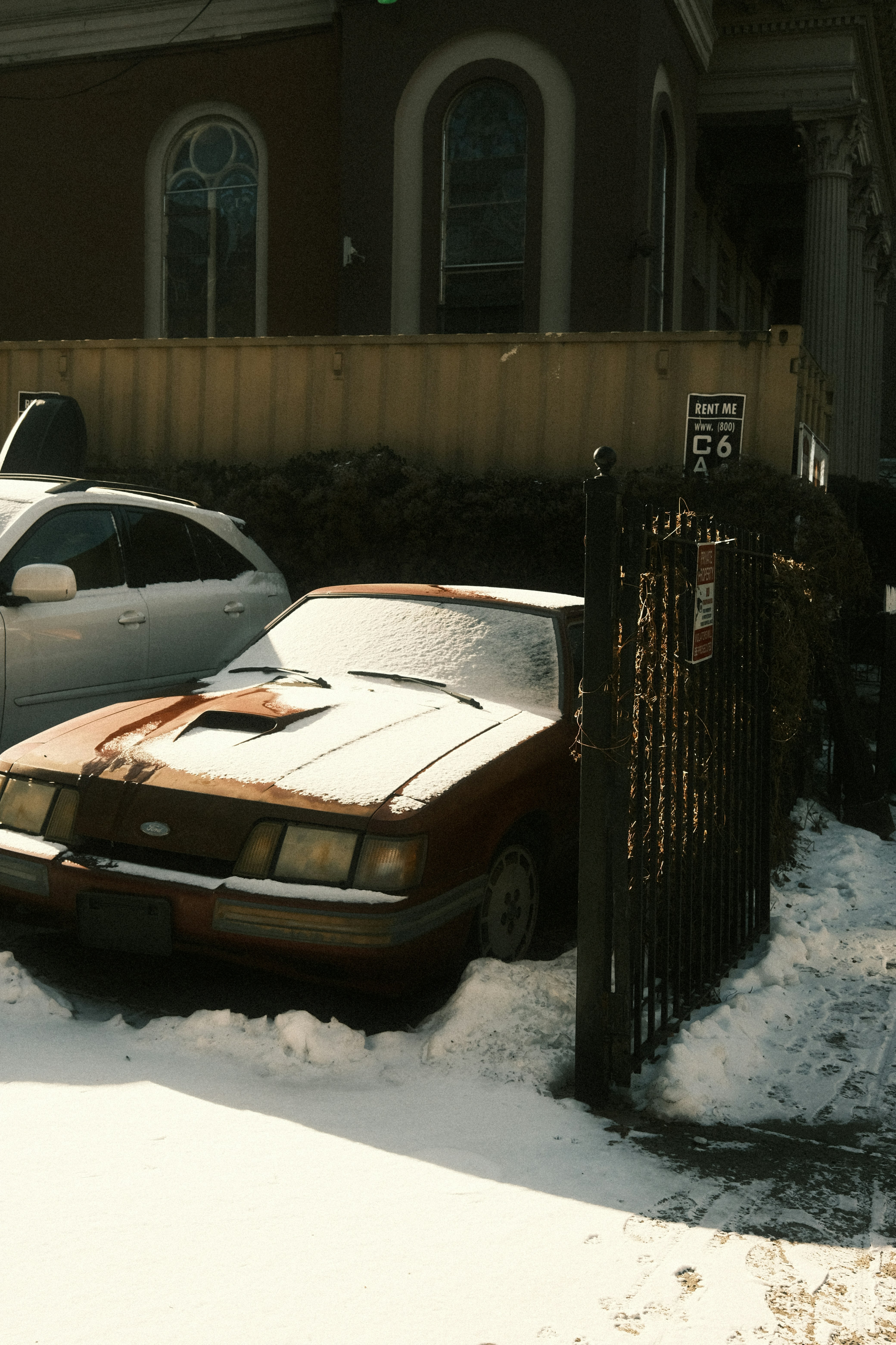 Snow-Topped Bronze Buick Guarded by Iron Gate