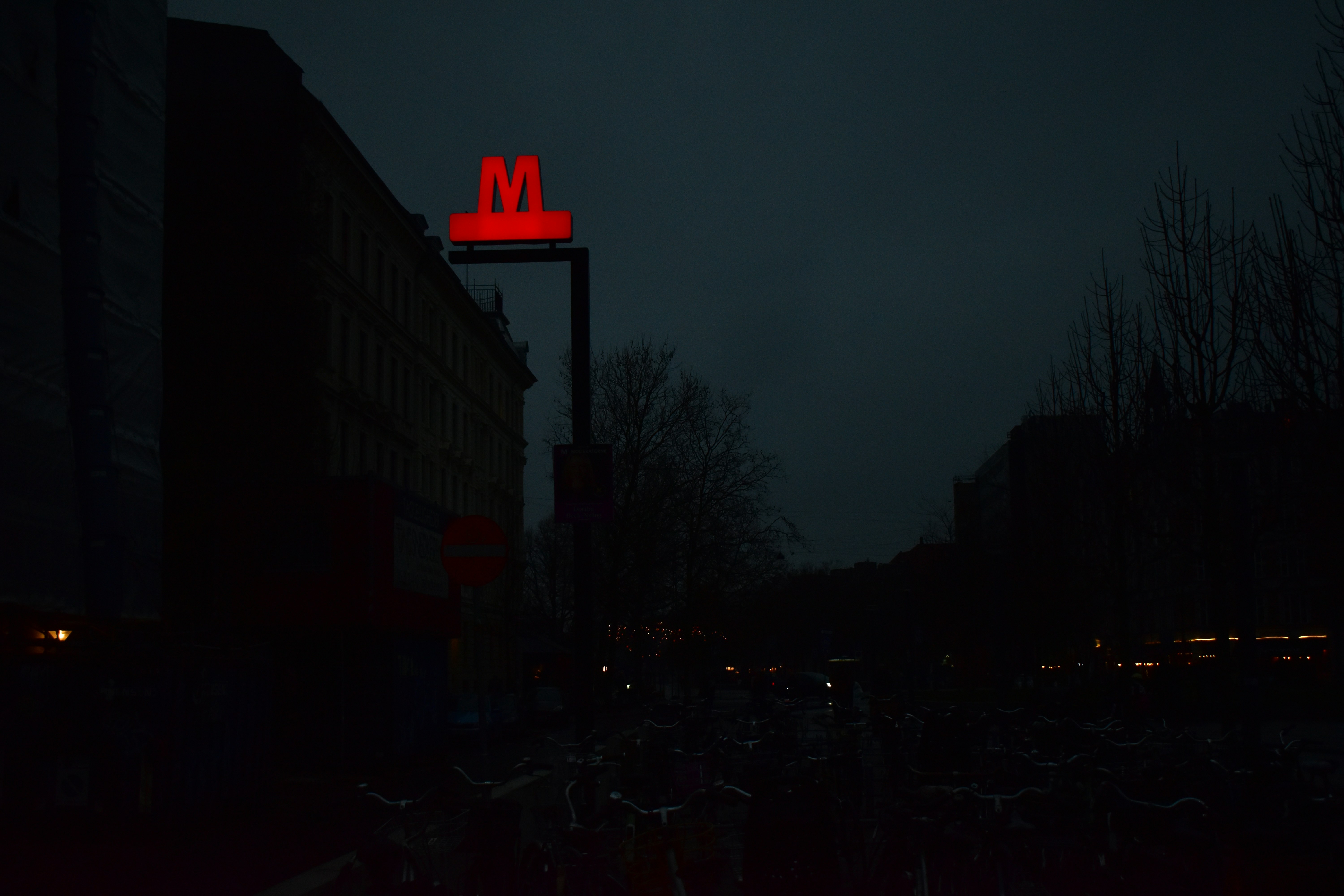 Neon M at Dusk: A Quiet Urban Night in Red