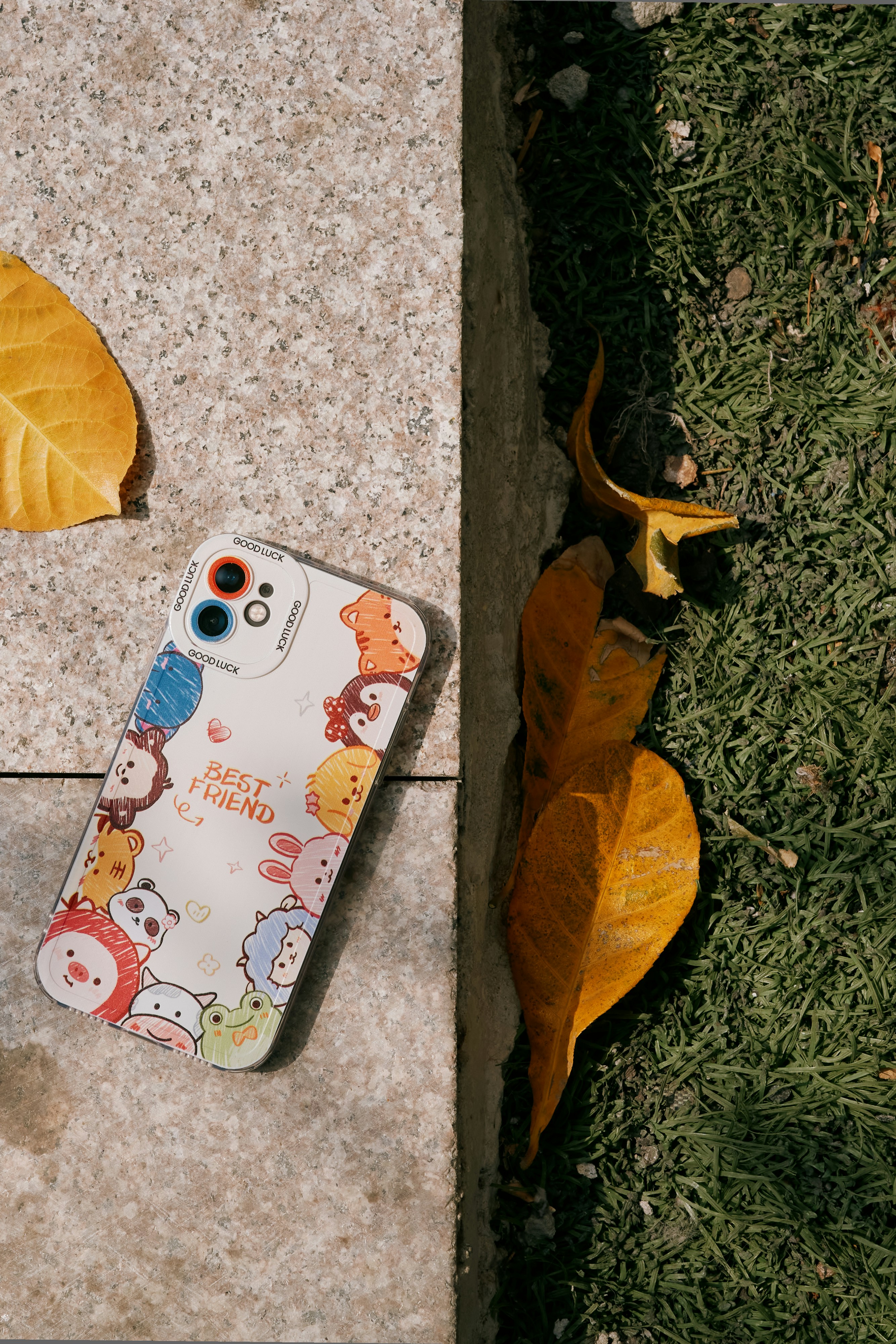 Colorful Cartoon-themed Phone Left on Concrete Step