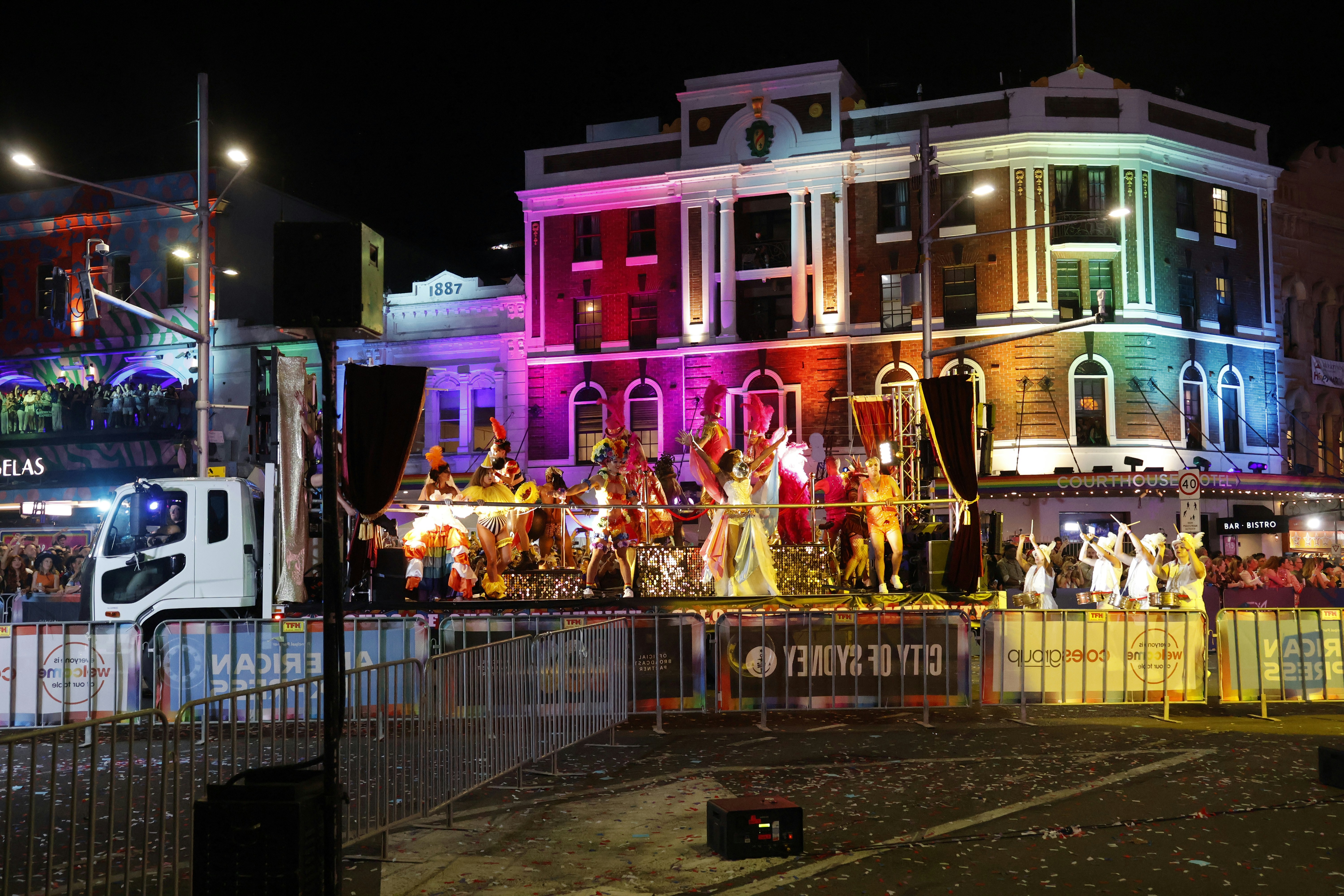 Nighttime Street Parade on a Neon-Illuminated City Hall Baroque Facade