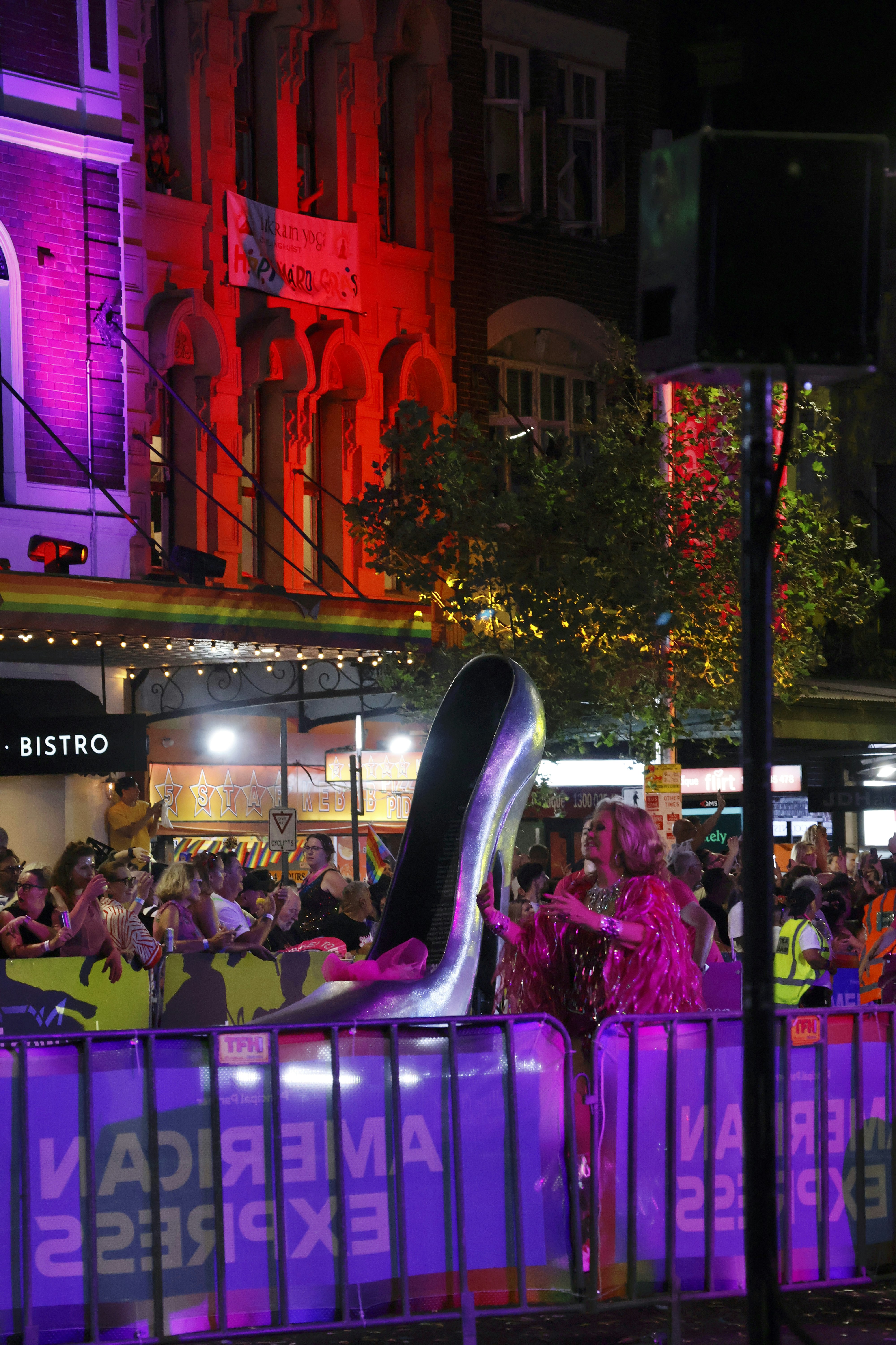 Neon Night on the High Street: A Giant Shoe Stands Guard