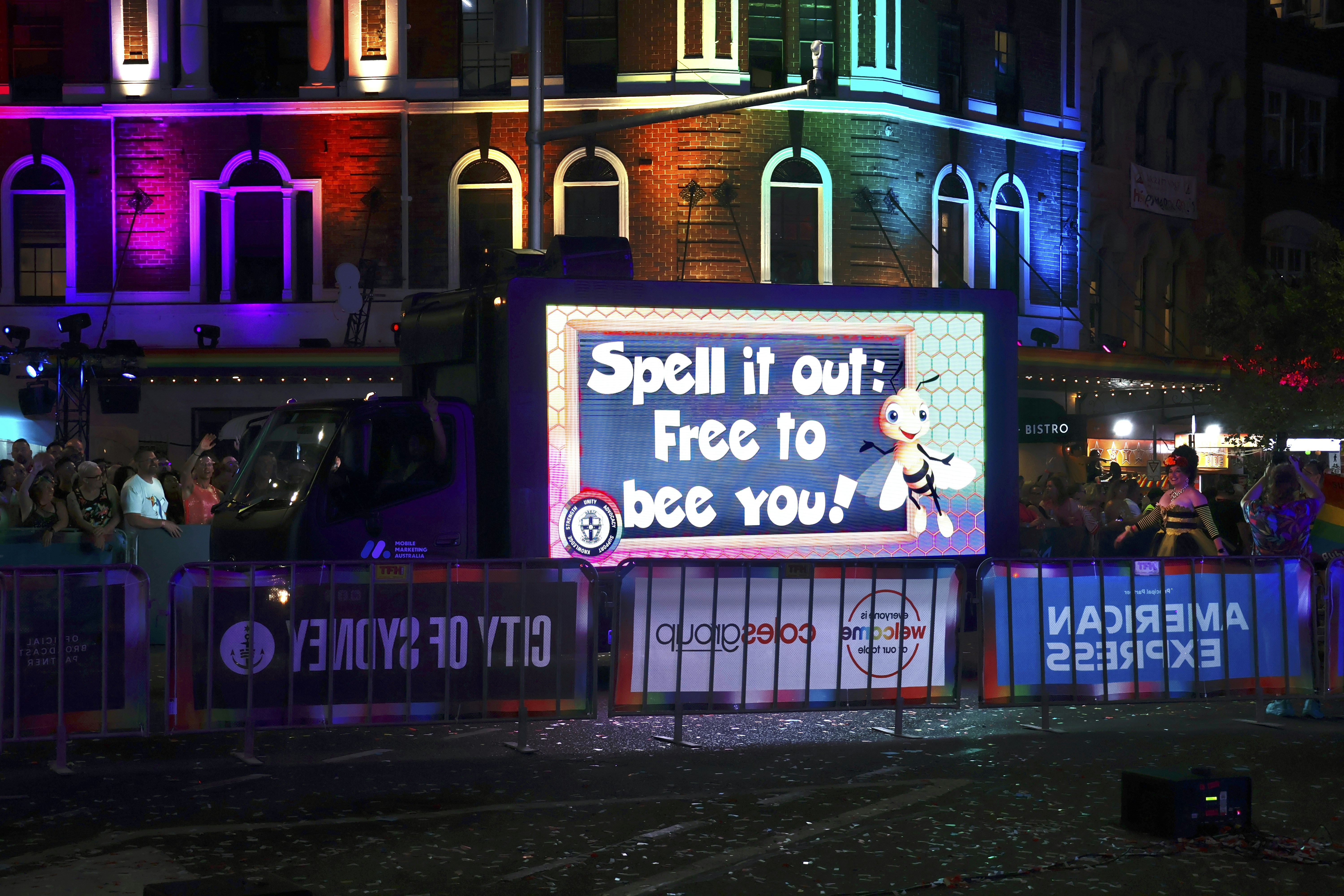 Neon-lit Parade Screen: Free to Be You on a City Night