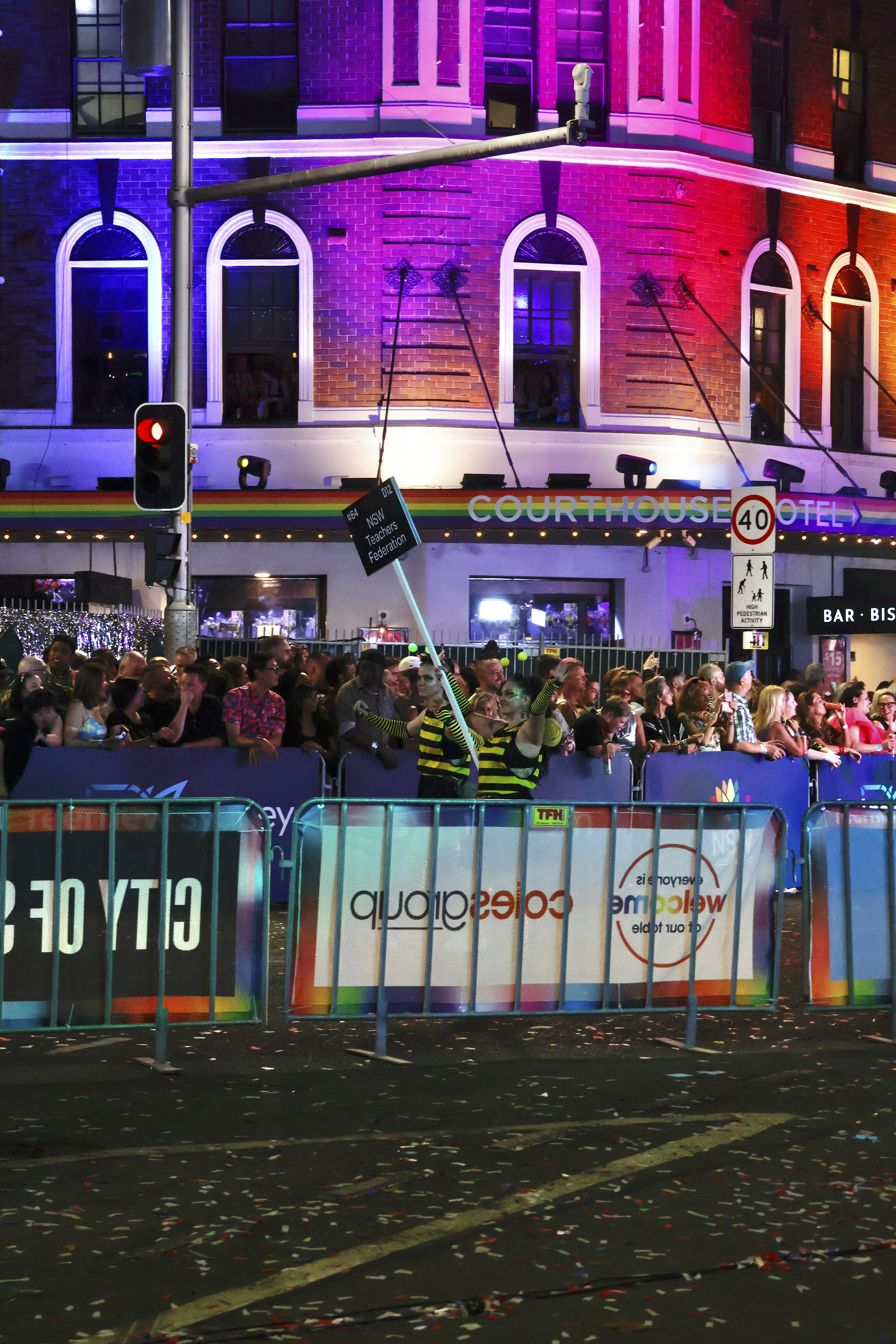 Neon Courtyard at Night: A Crowd Beneath the Colored Facade