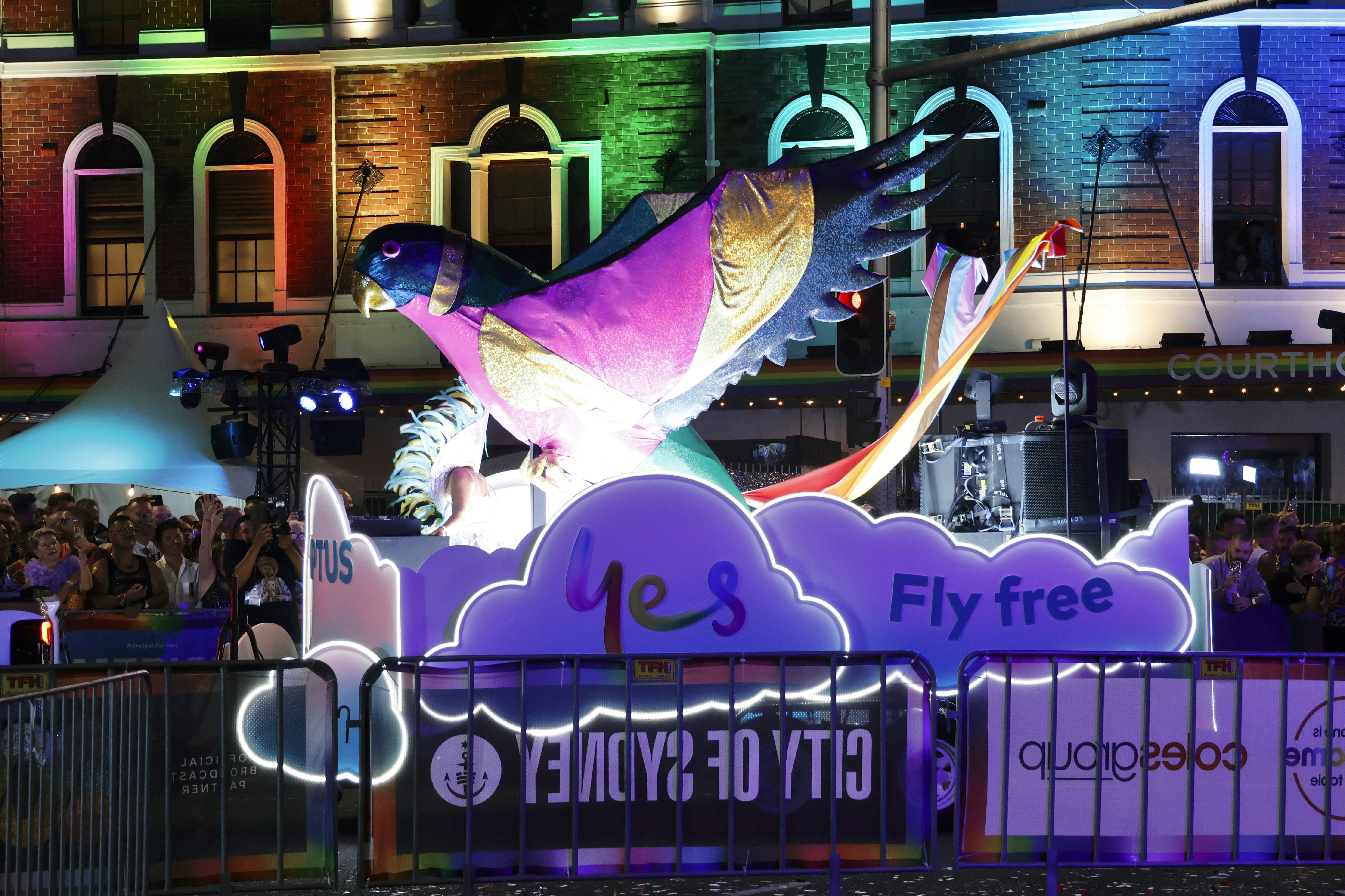 Emerald Winged Flyer Over a Neon CLOUDS Parade Barque