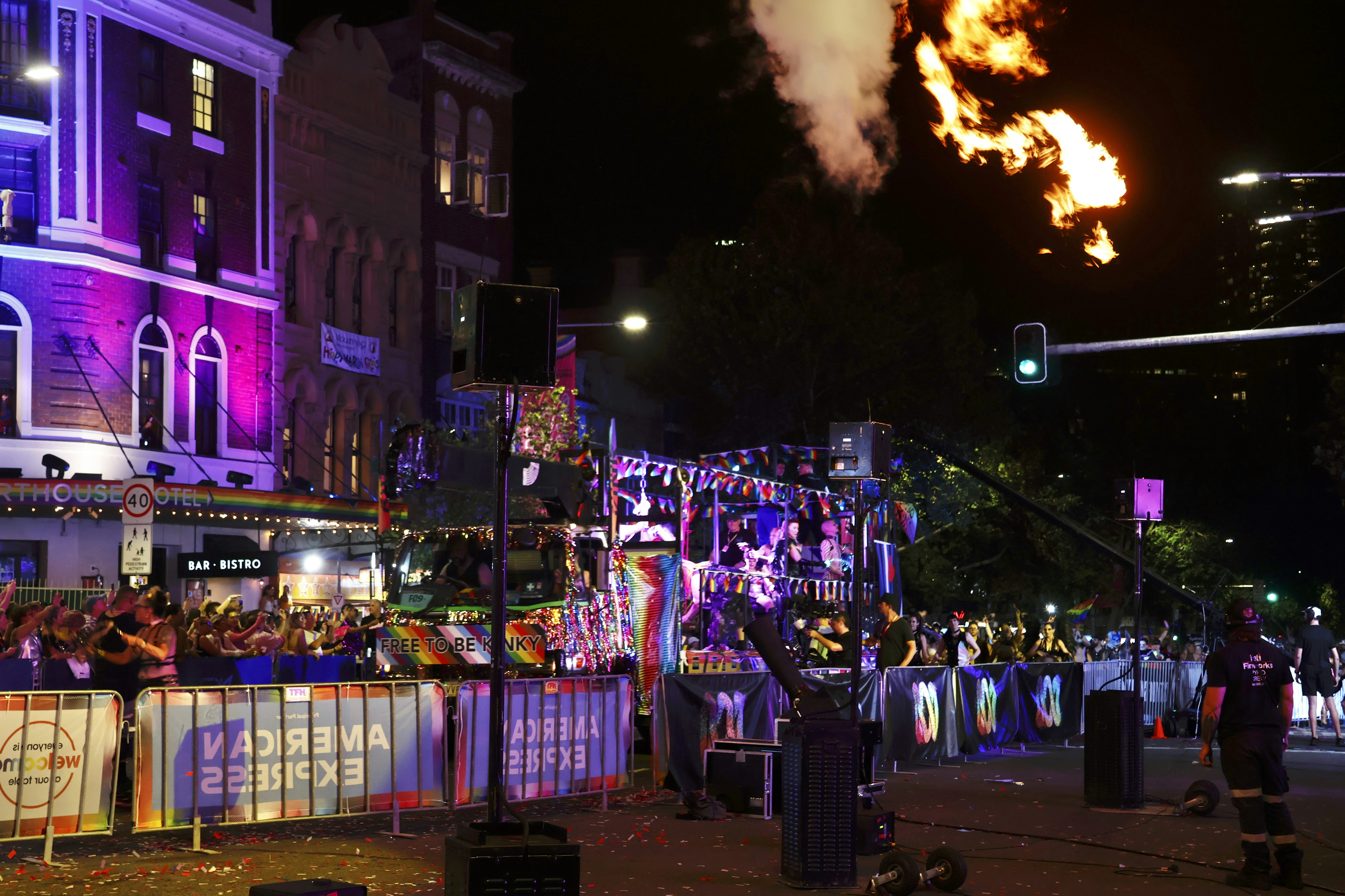 Flaming Parade Lights Overflow a Lively City Street