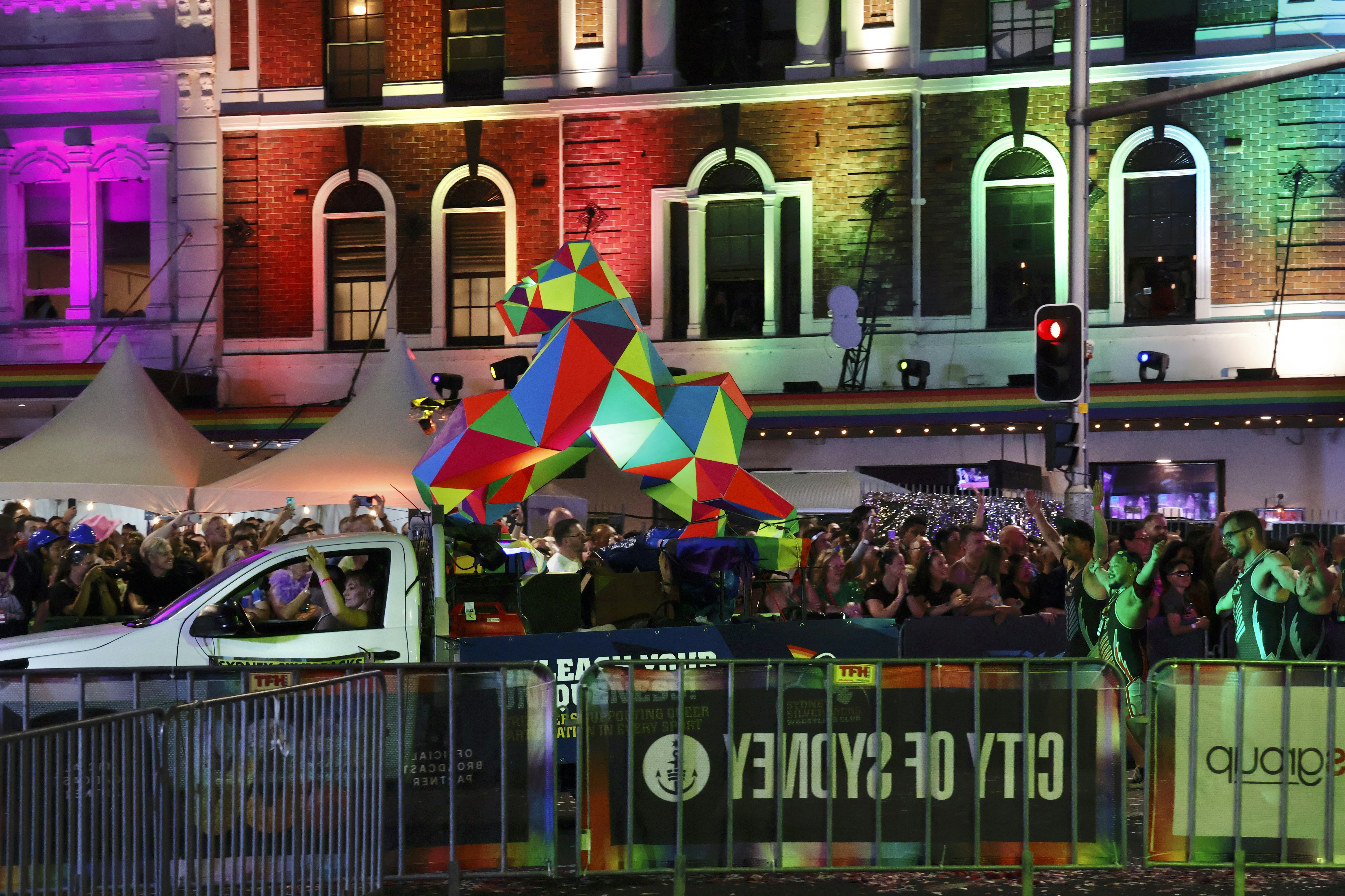 Multicolor Geometric Kite Hovering Above a Live Parade