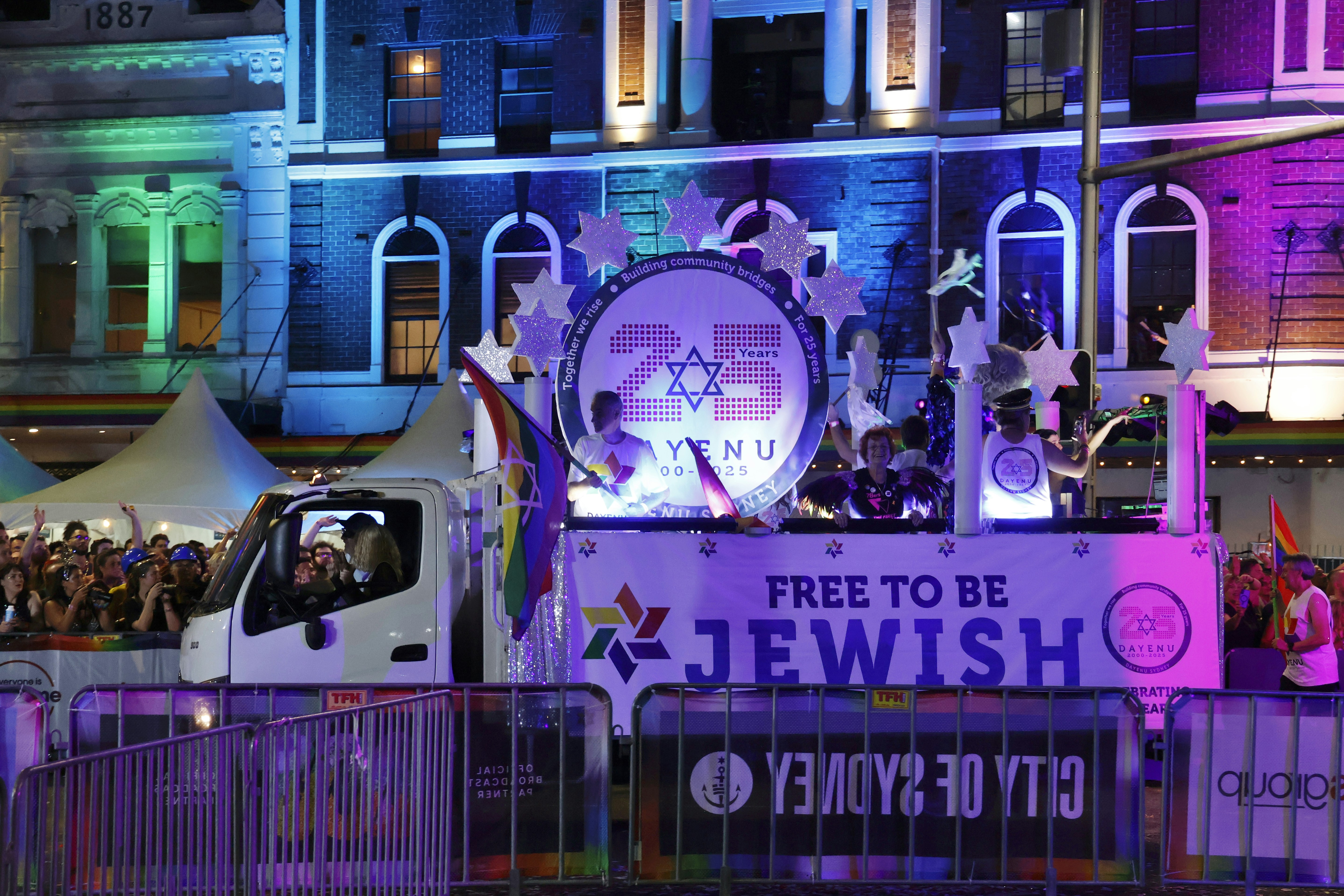 Illuminated Pride Parade Float Traverses a Neon Night