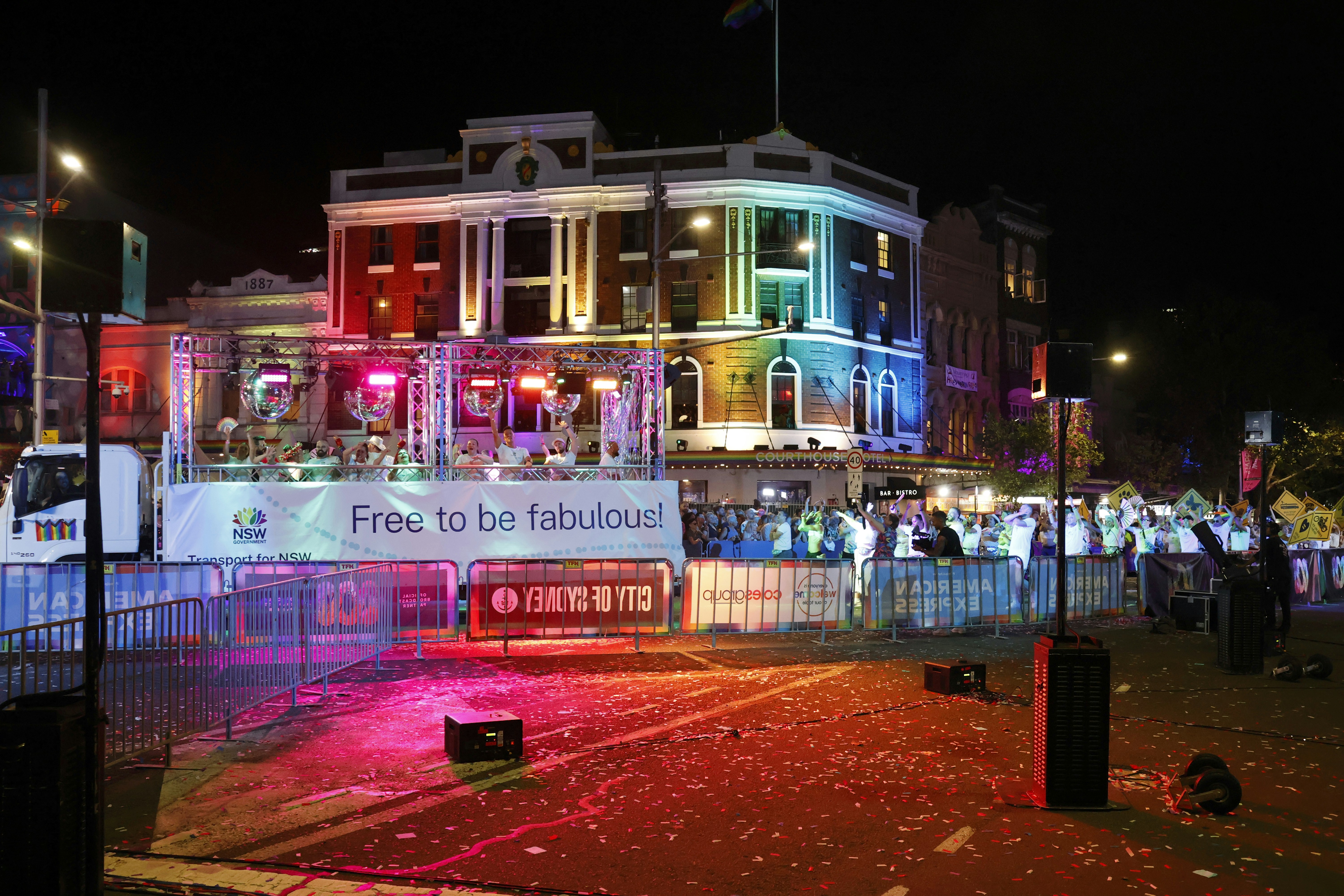 Neon Facade: A Night Parade Illuminates a Historic Corner