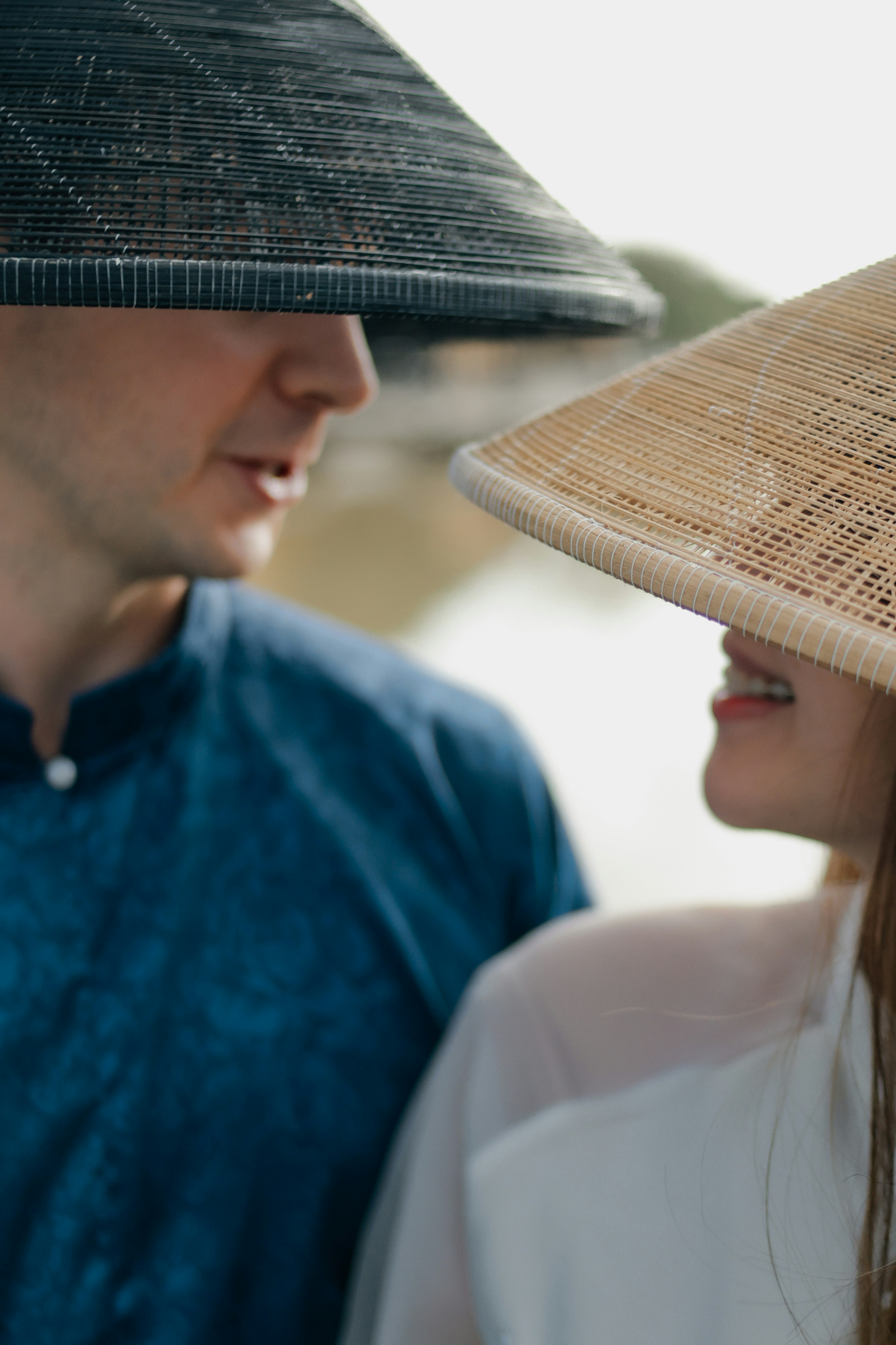 Two Straw Hats, One Moment: A Quiet Exchange Under Soft Light