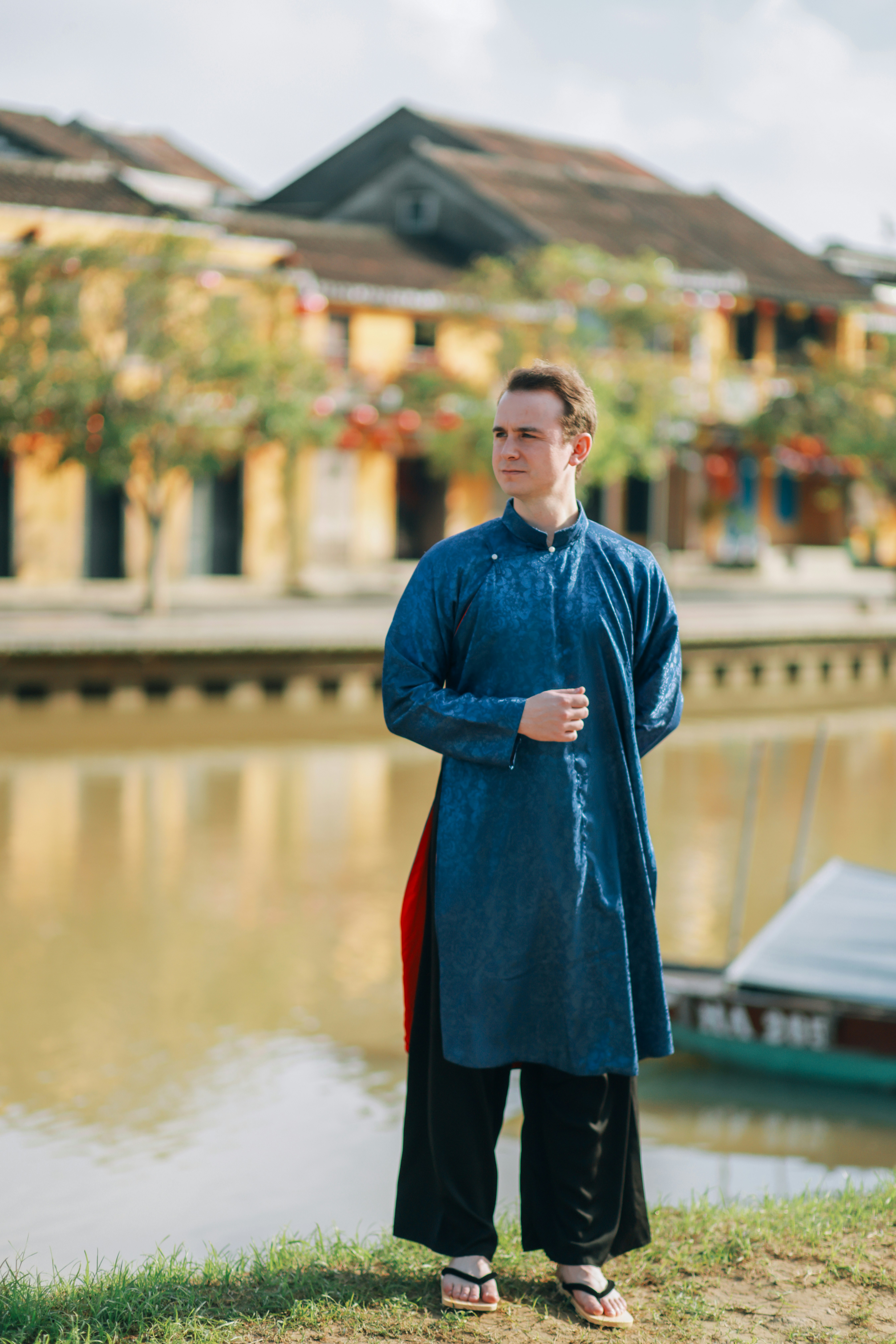 Blue Tunic at Water's Edge: A Quiet Portrait by the Riverside