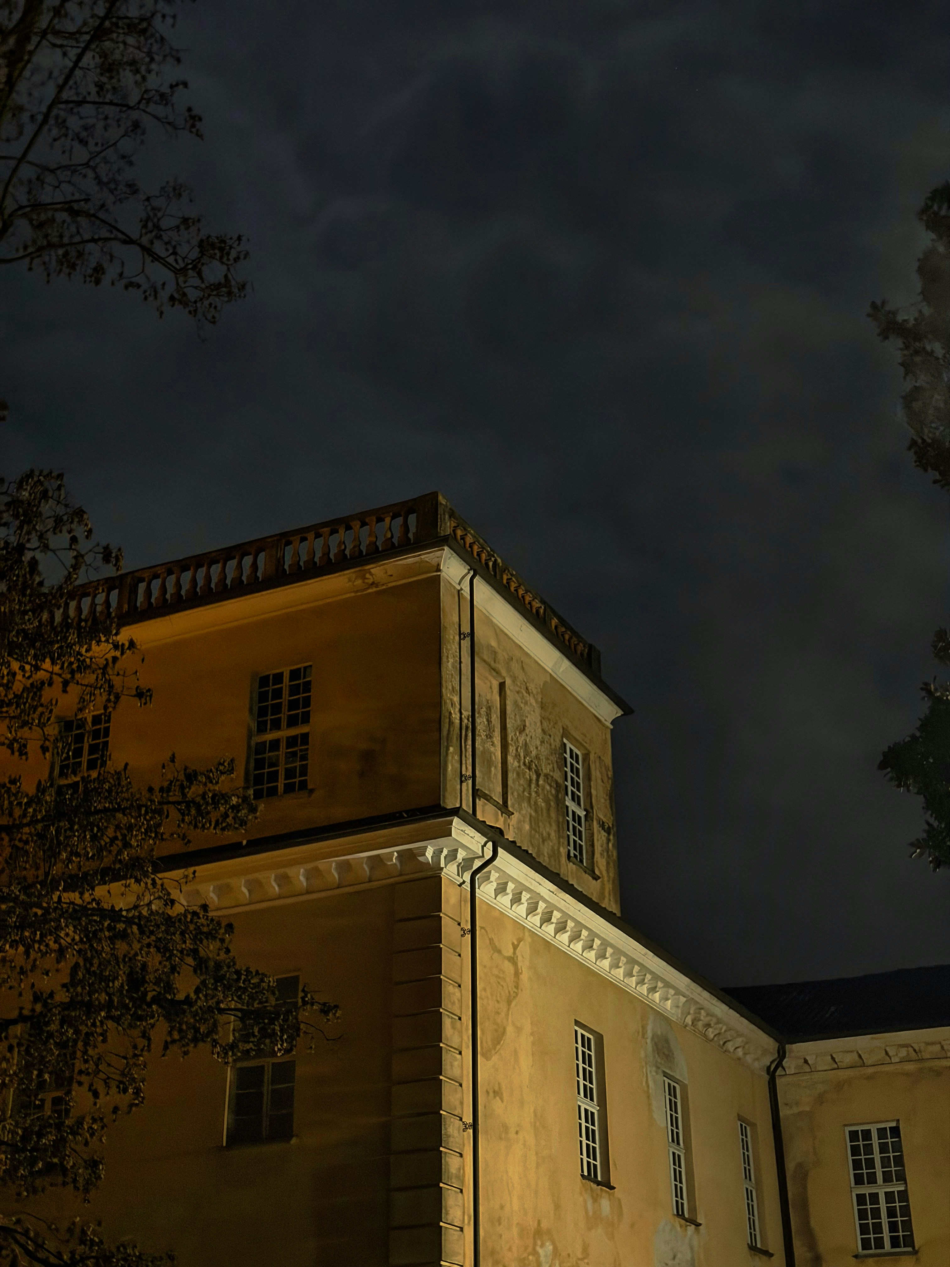 Moonlit Manor: A Corner Tower Basks in Quiet Nightlight