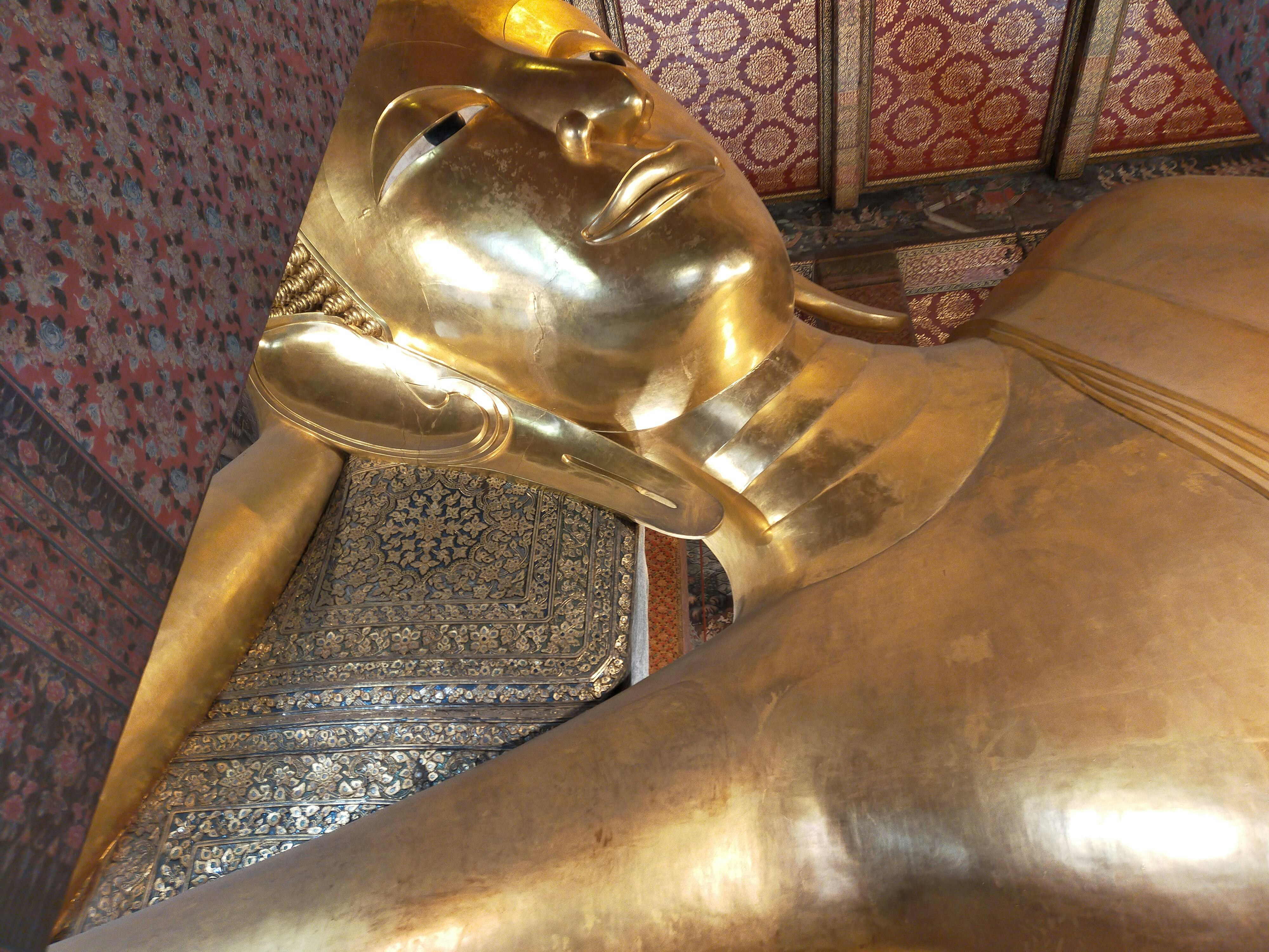 Large golden reclining buddha statue