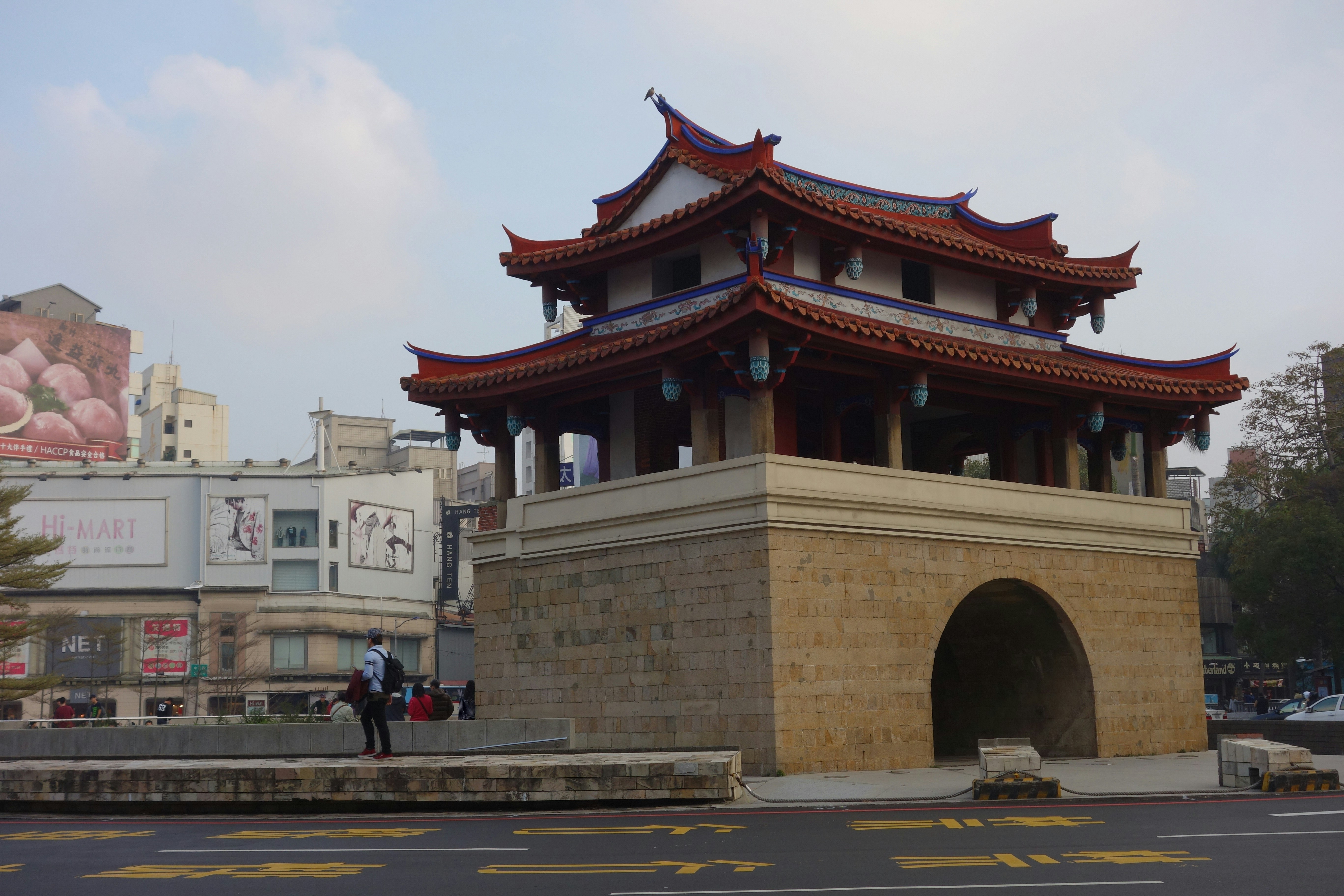Gateway of Echoes: A Historic Gatehouse Rising Over Modern Streets
