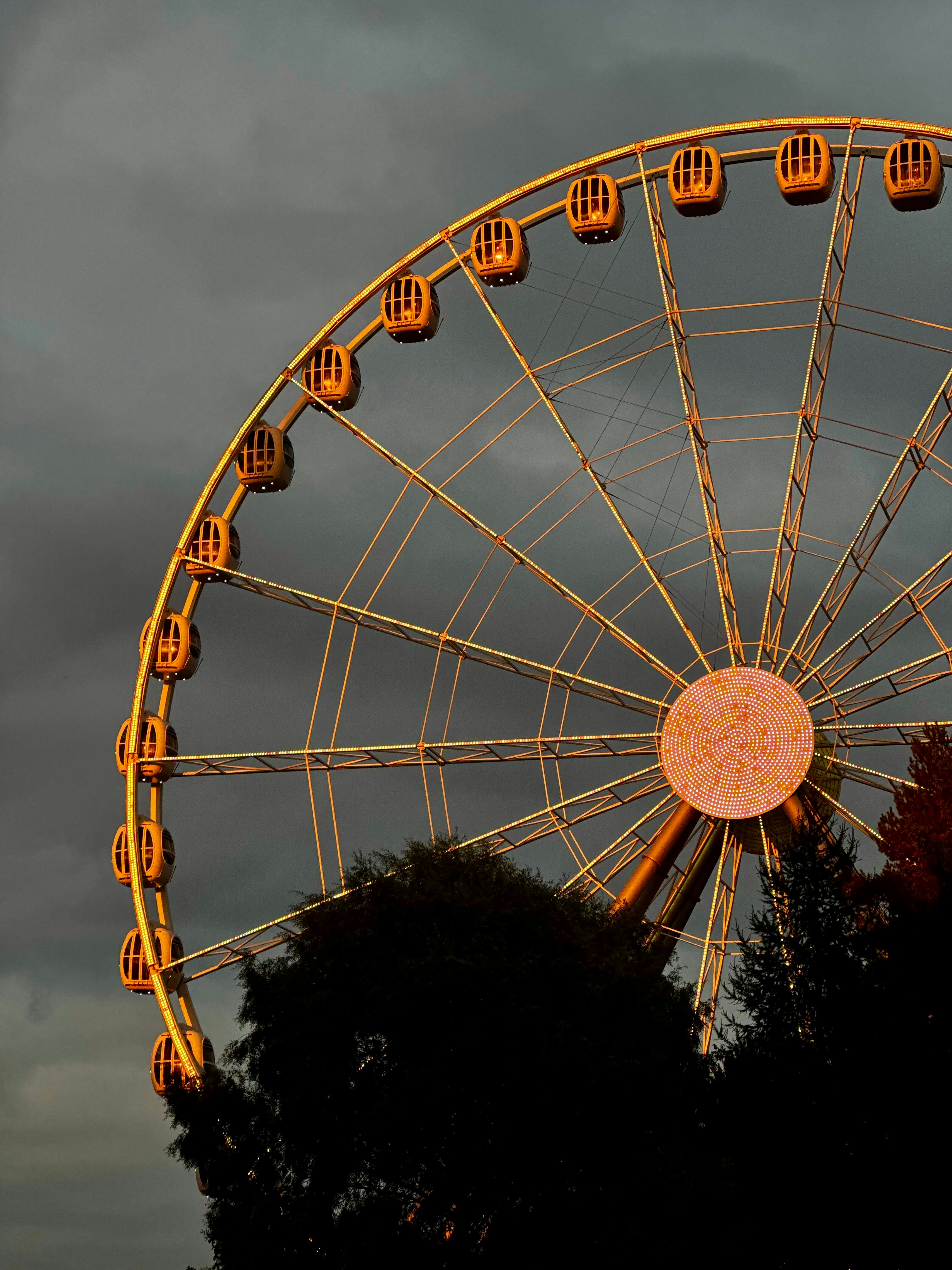 Golden Wheel: A Sunset Silhouette of the City’s Giant Ferris Wheel