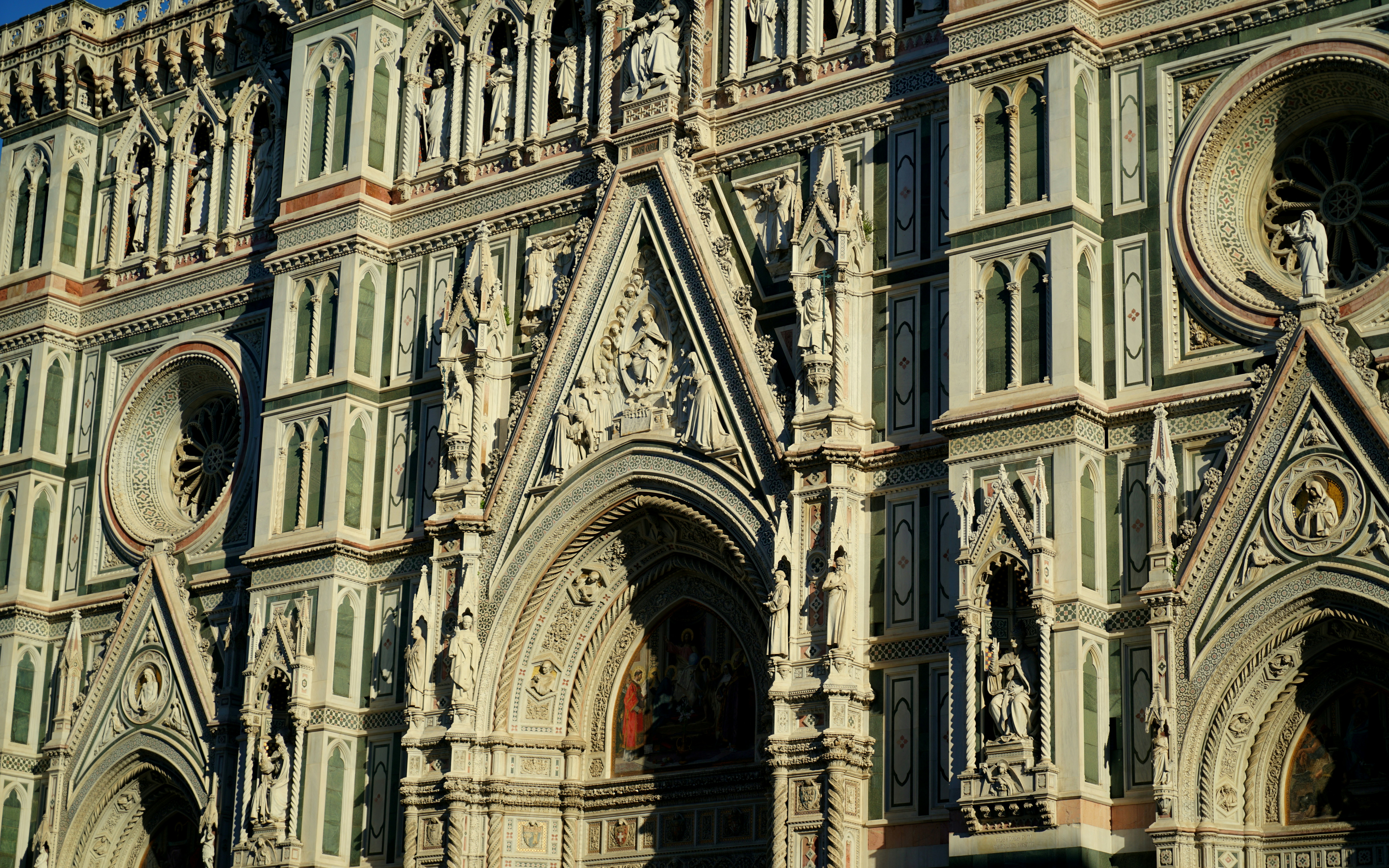 Gothic Revival Facade: Carved Arcades and Statues Framing a Grand Portal