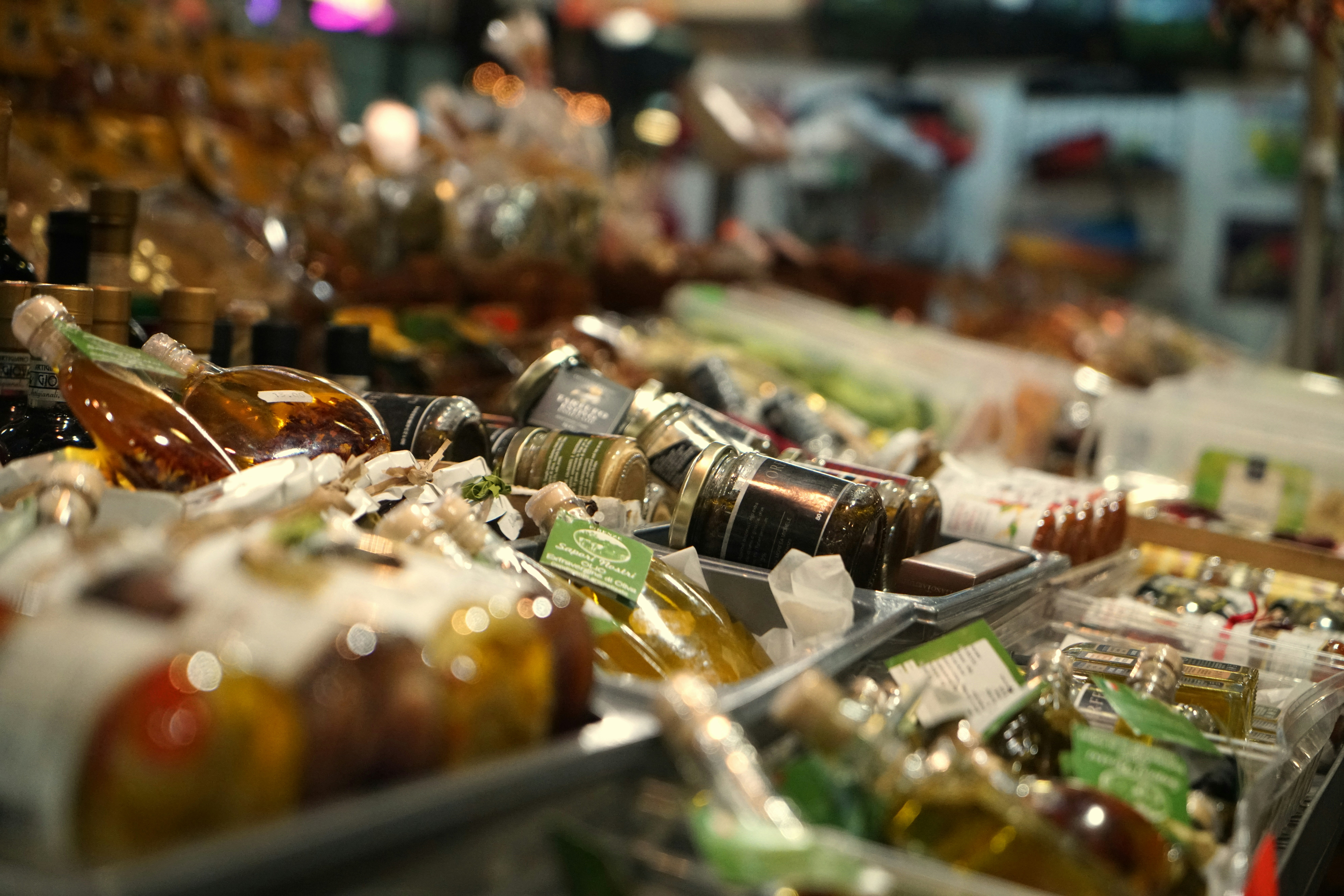 Bottled Sweetness: A Glimpse of Market Color Amid Glass and Gold