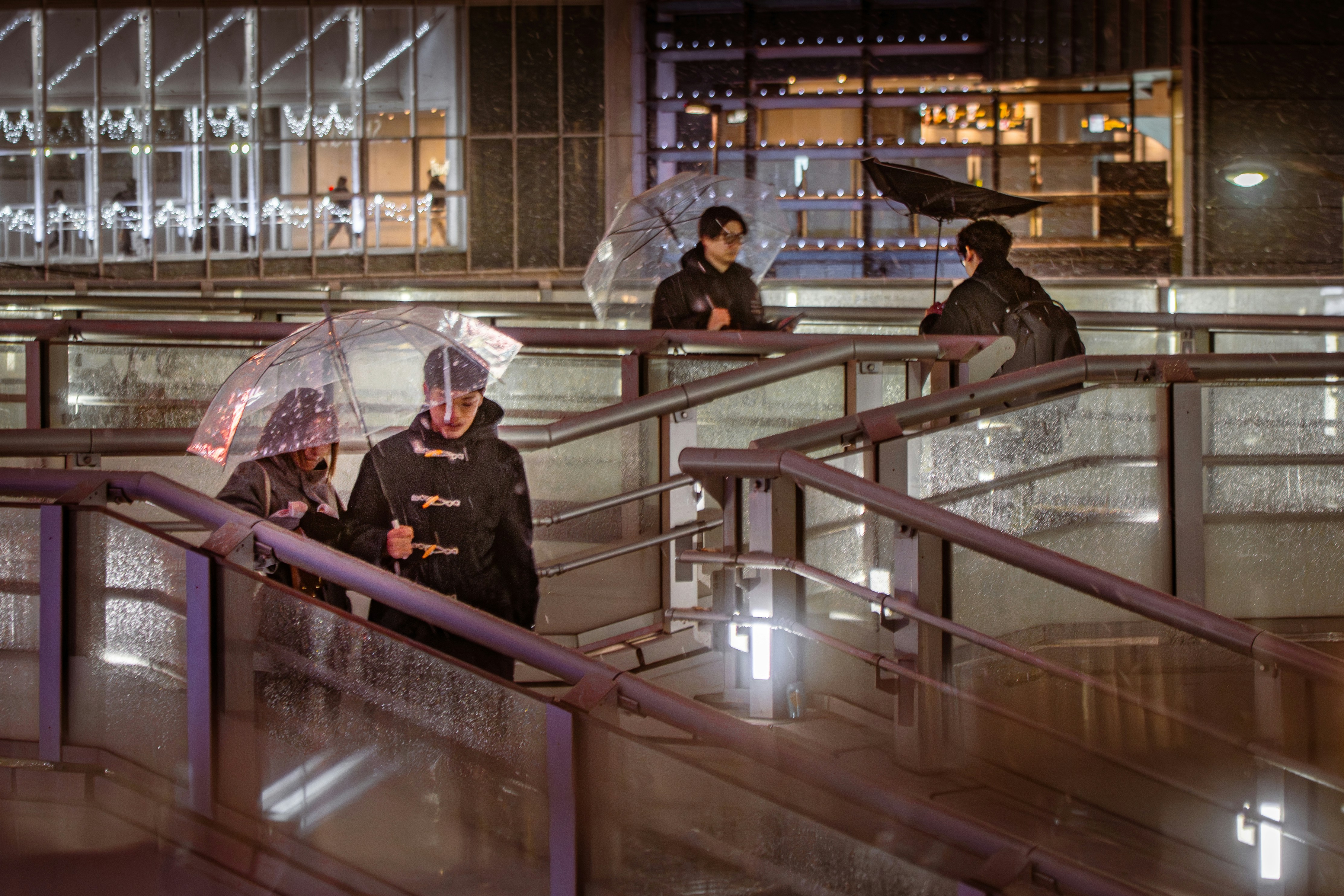 Midnight Crossing: Umbrella Lights and Quiet Conversations on Rainy Steps