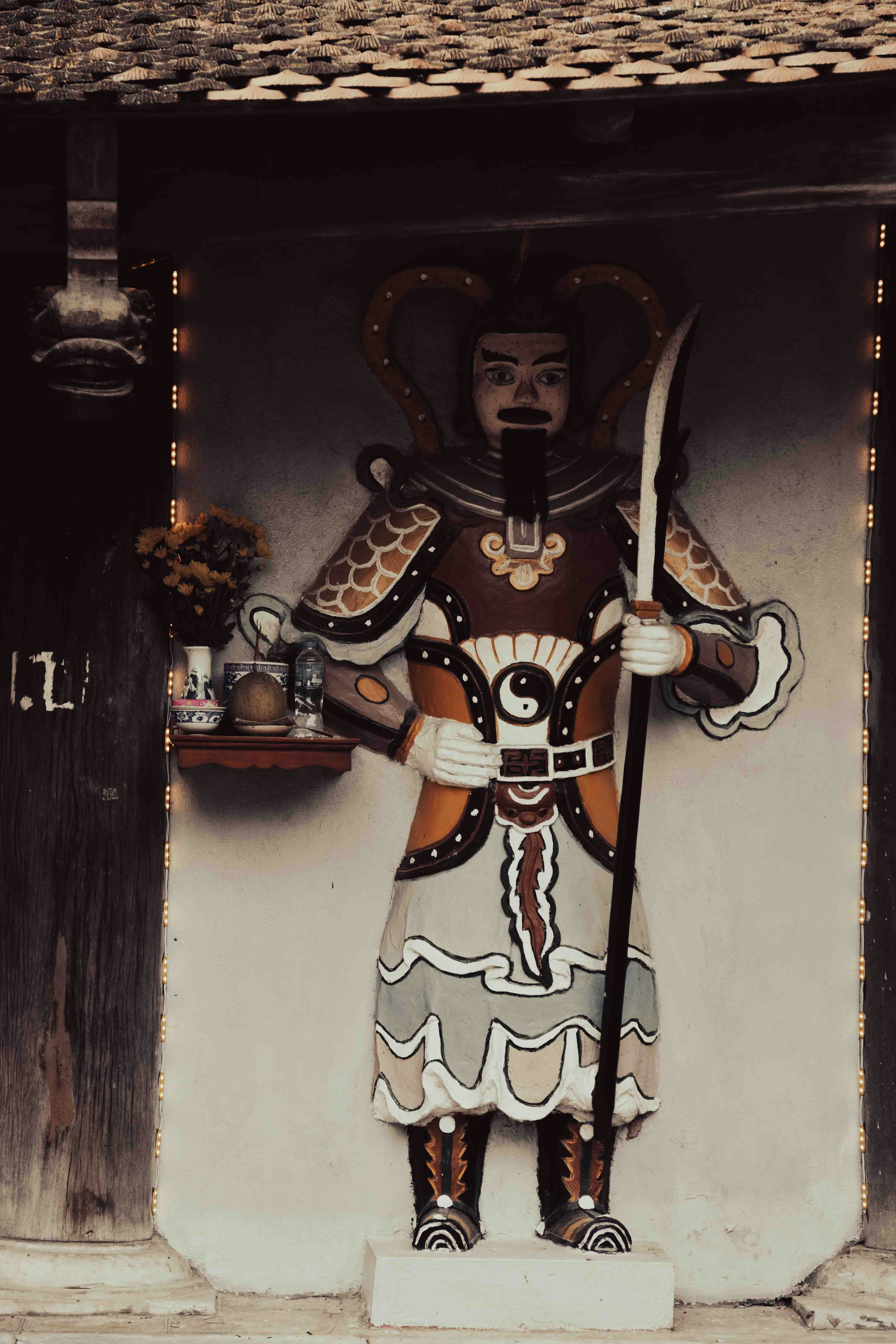 Guardian of the Shrine: A Painted Warrior Stands in Silent Vigil