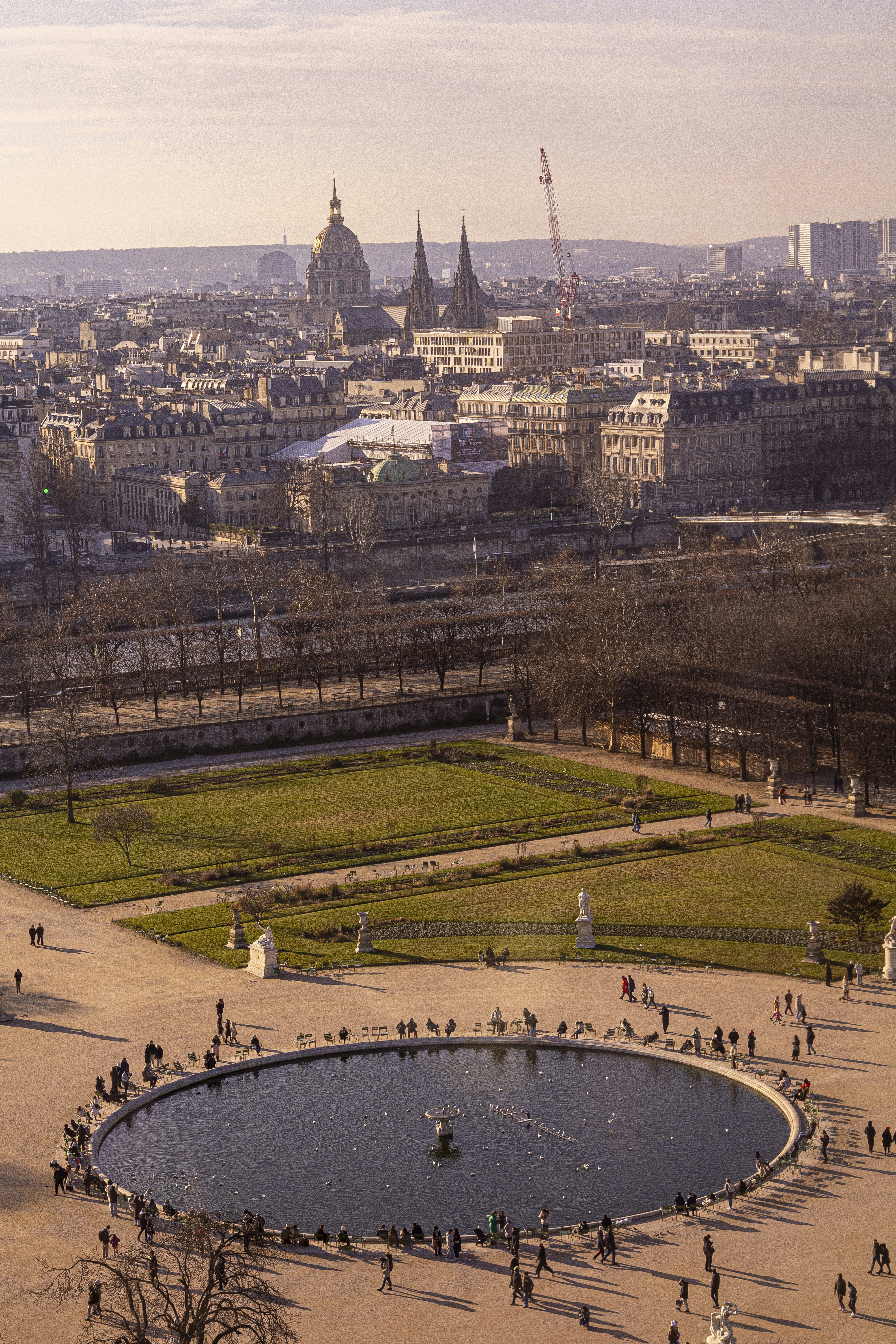 Circular Fountain, City Skyline, and Cathedral Spires at Sunset