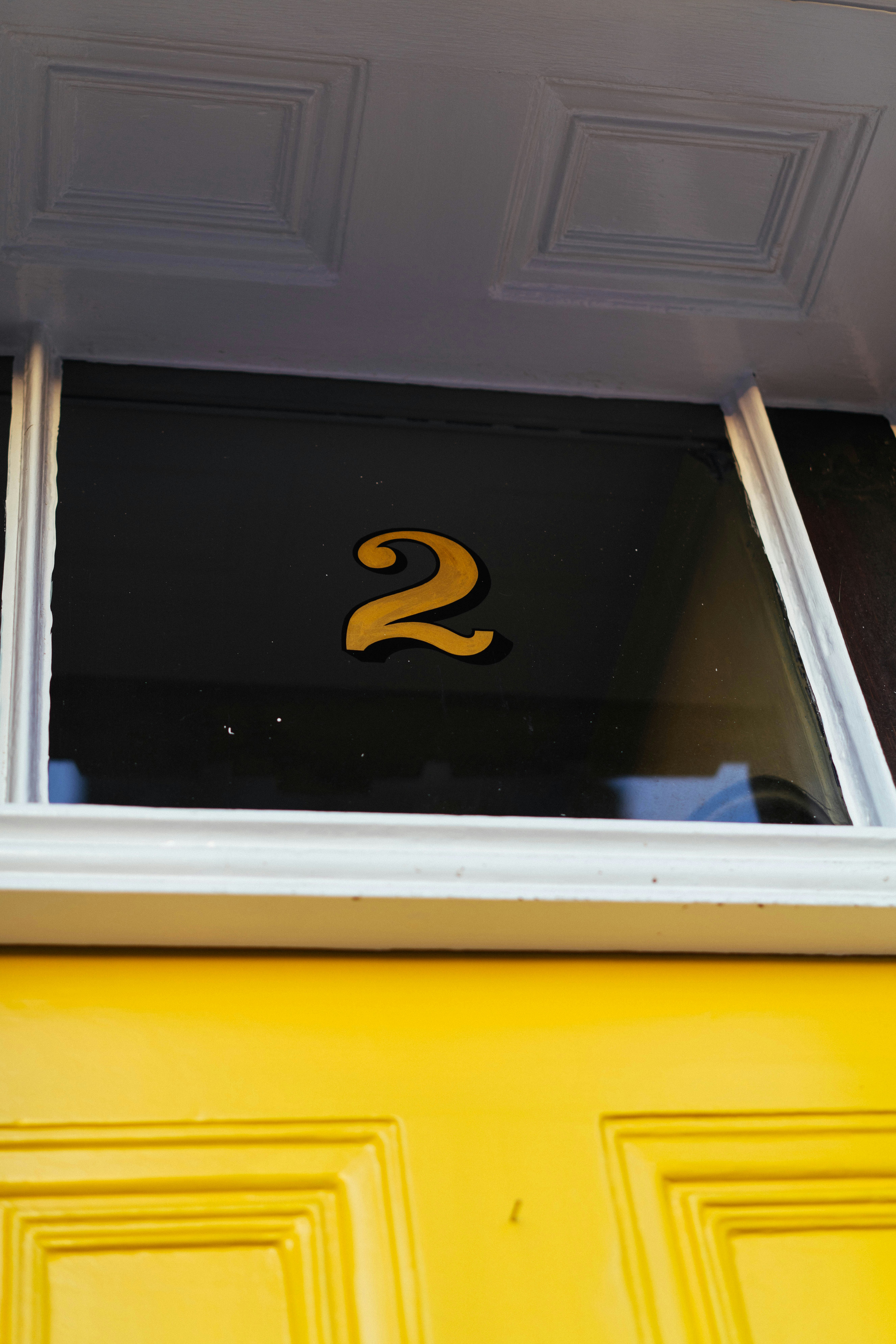 Doorway to Number Two: A Bold Yellow Entrance